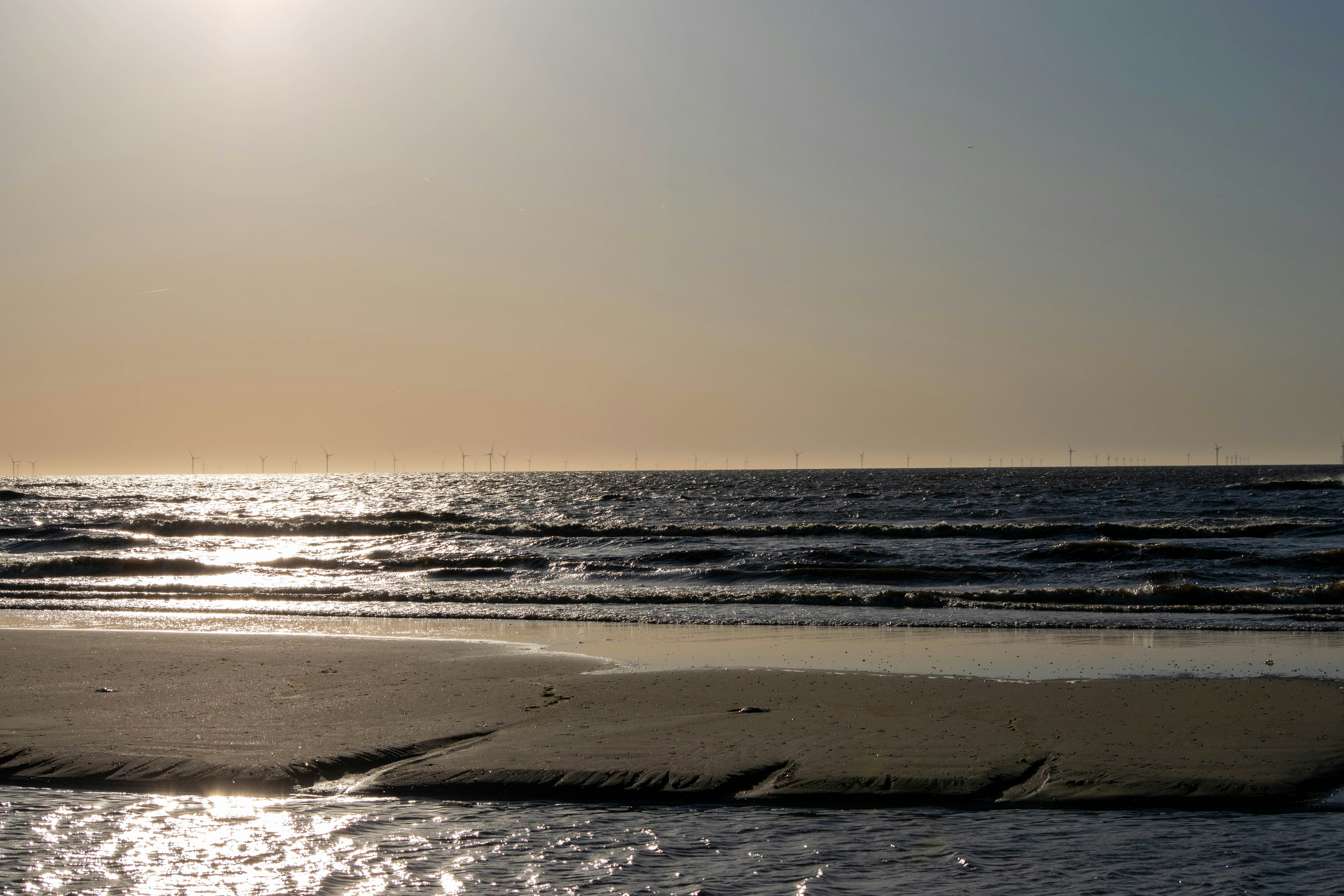 Sunlit Tidefront: Quiet Beach at Dusk