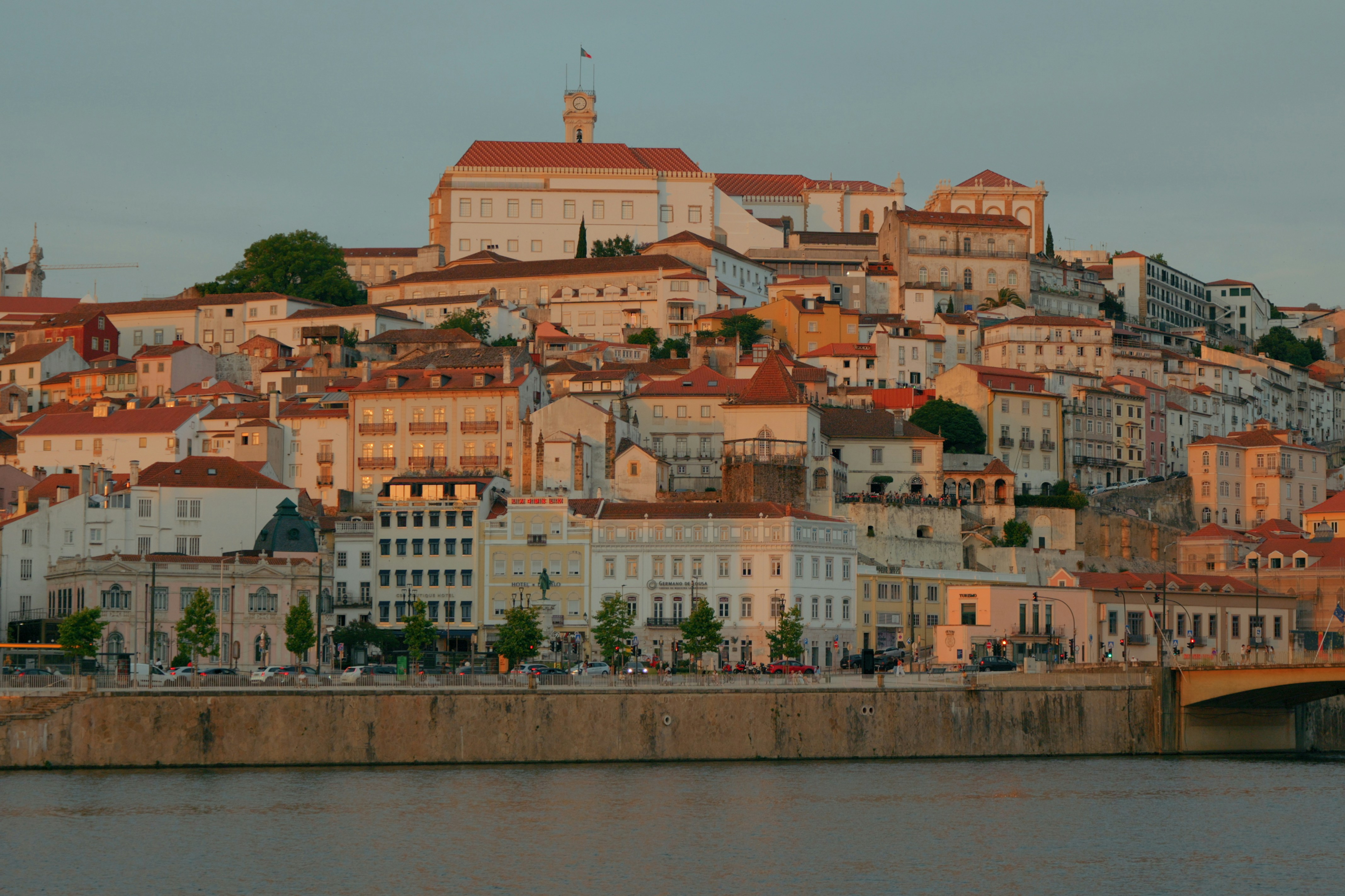 Riverside Citadel: Sunlit Hillside Town Across the Water