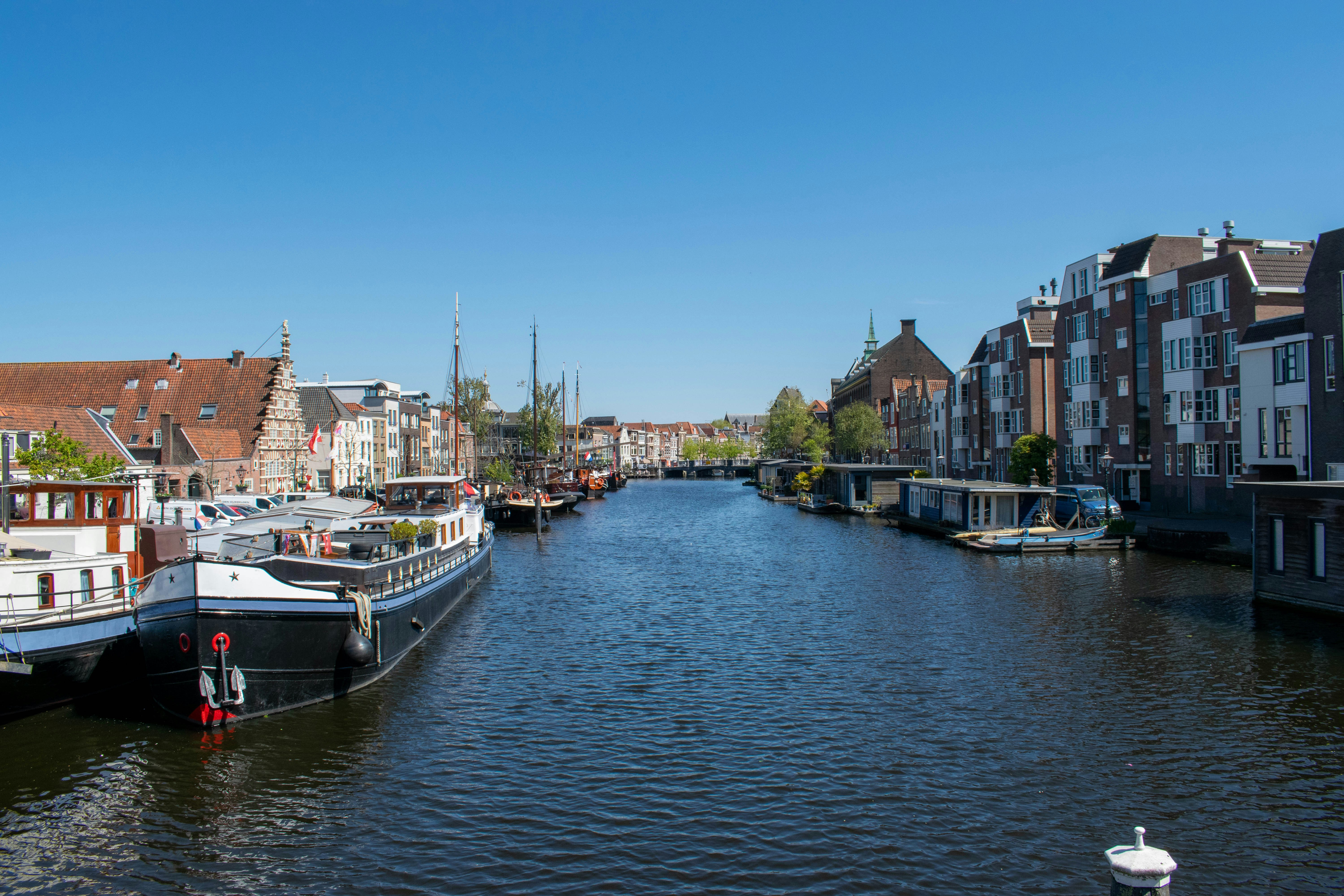 Canal View: Boats, Brick Facades, and a Bright Dutch Afternoon