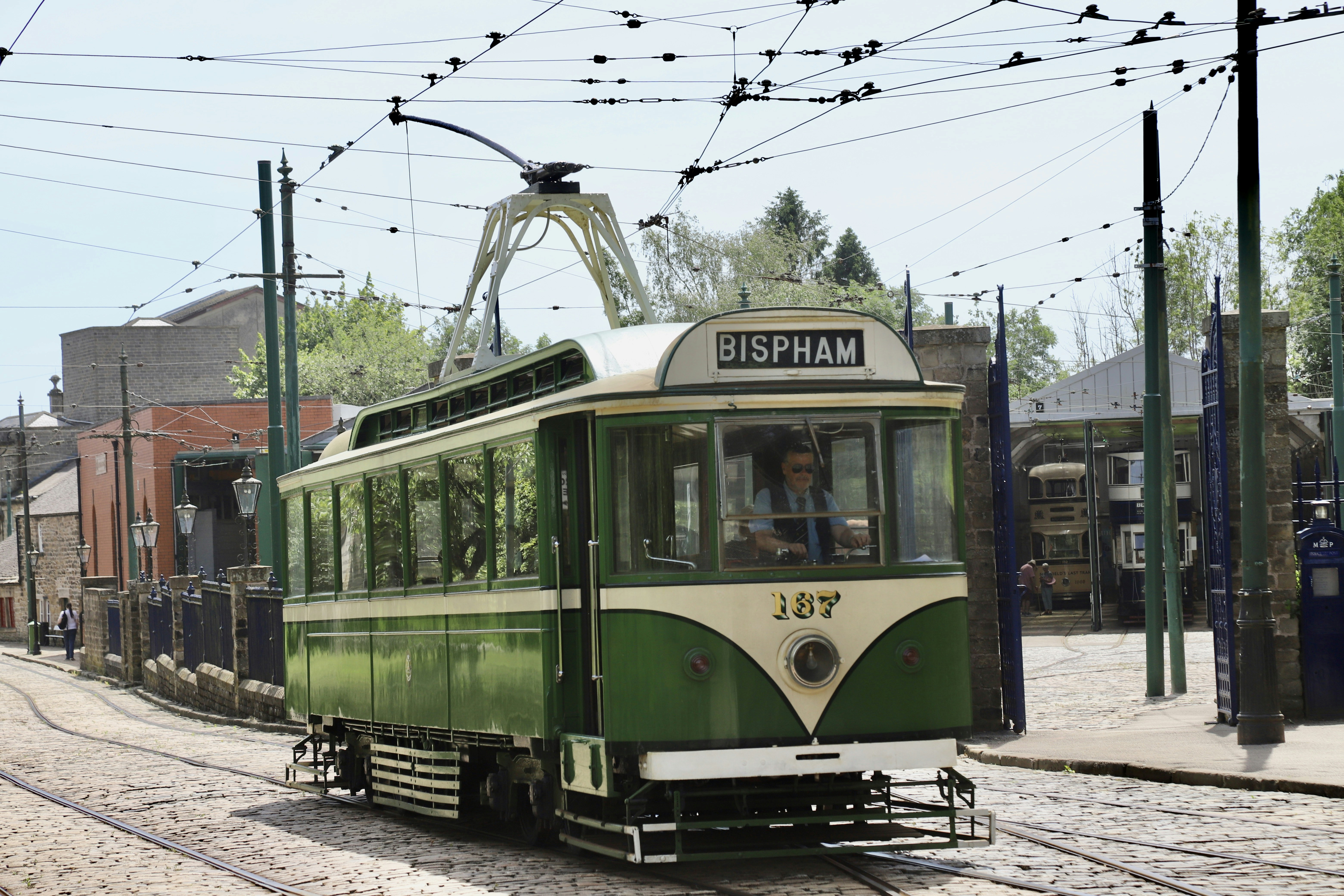 Heritage Tram on Cobbled Tracks: A Green Car Rumbles Through Bispham