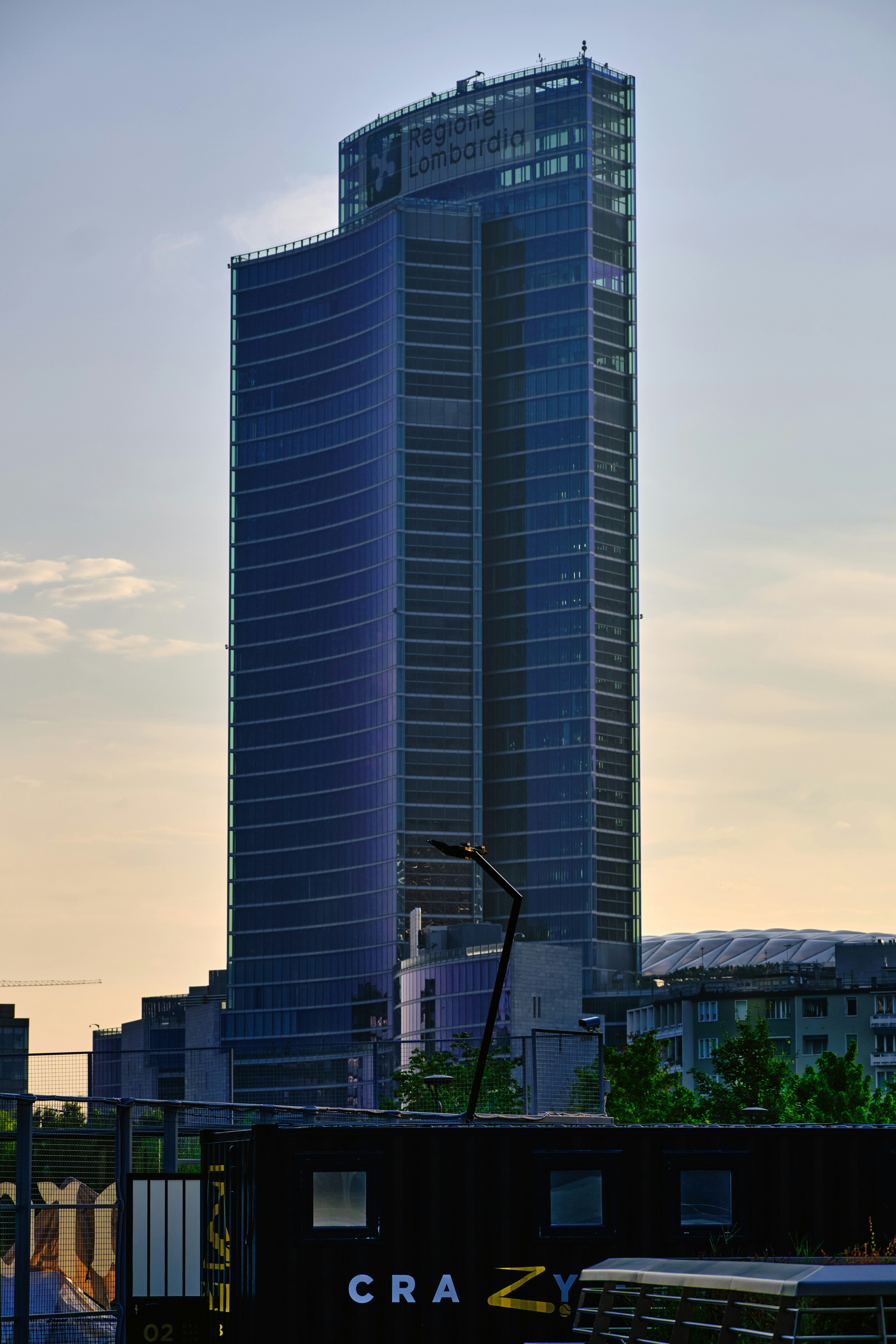 Skyward Lombardy: Tower Looms Over a Quiet Construction Podium