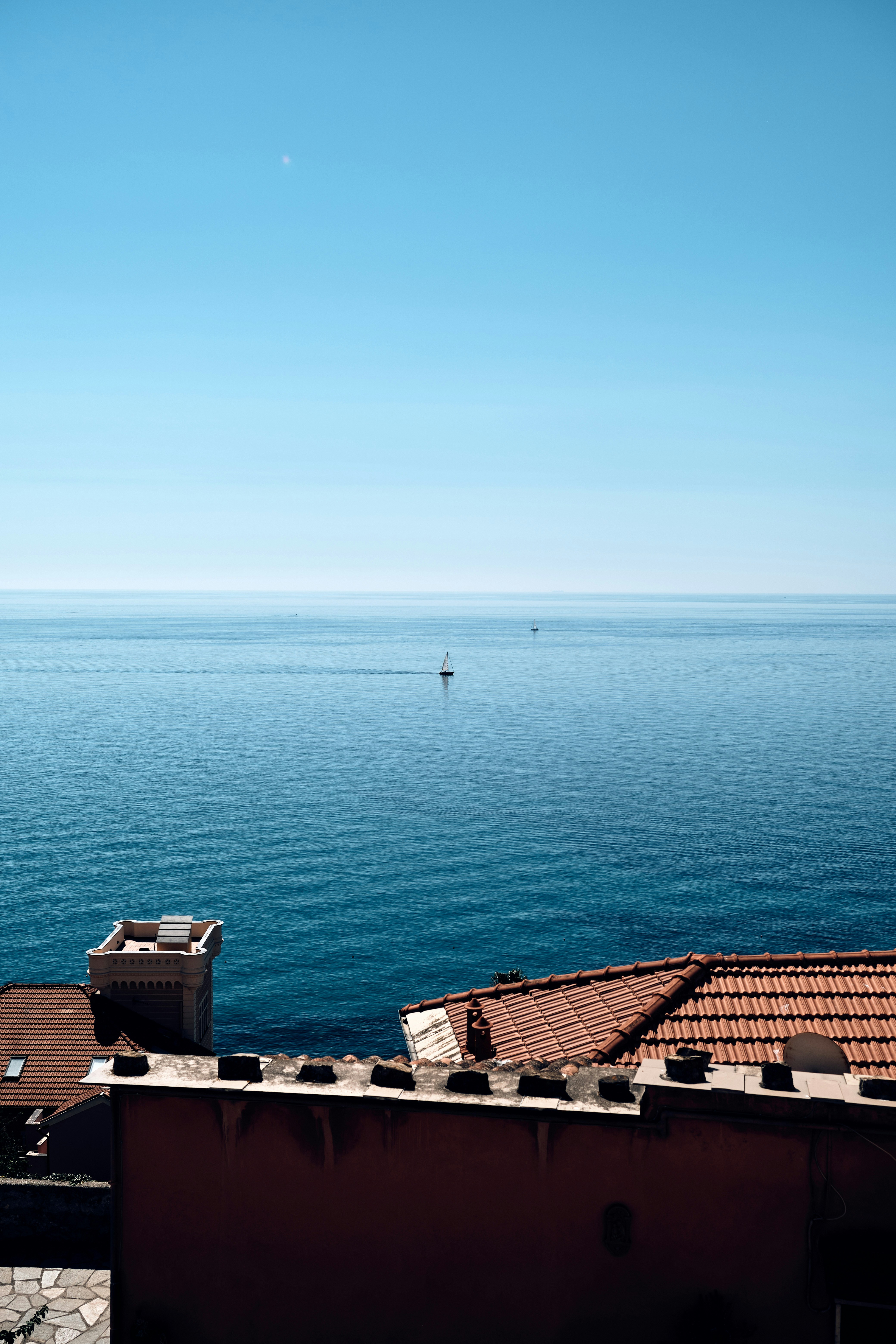 Terracotta Rooftops Framing a Calm Sea