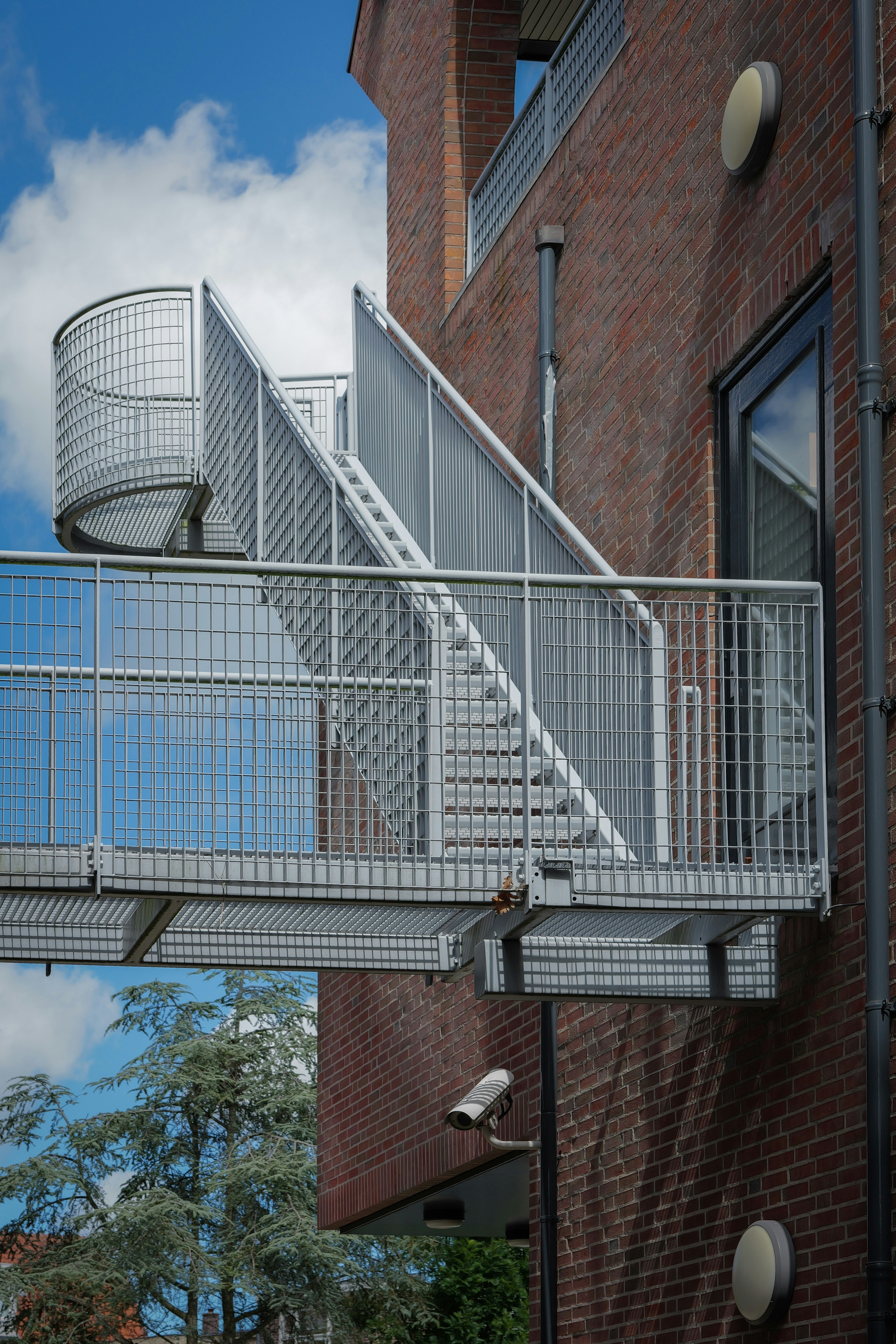 Industrial Staircase Against Brick: A Steel Path Climbing Toward the Sky