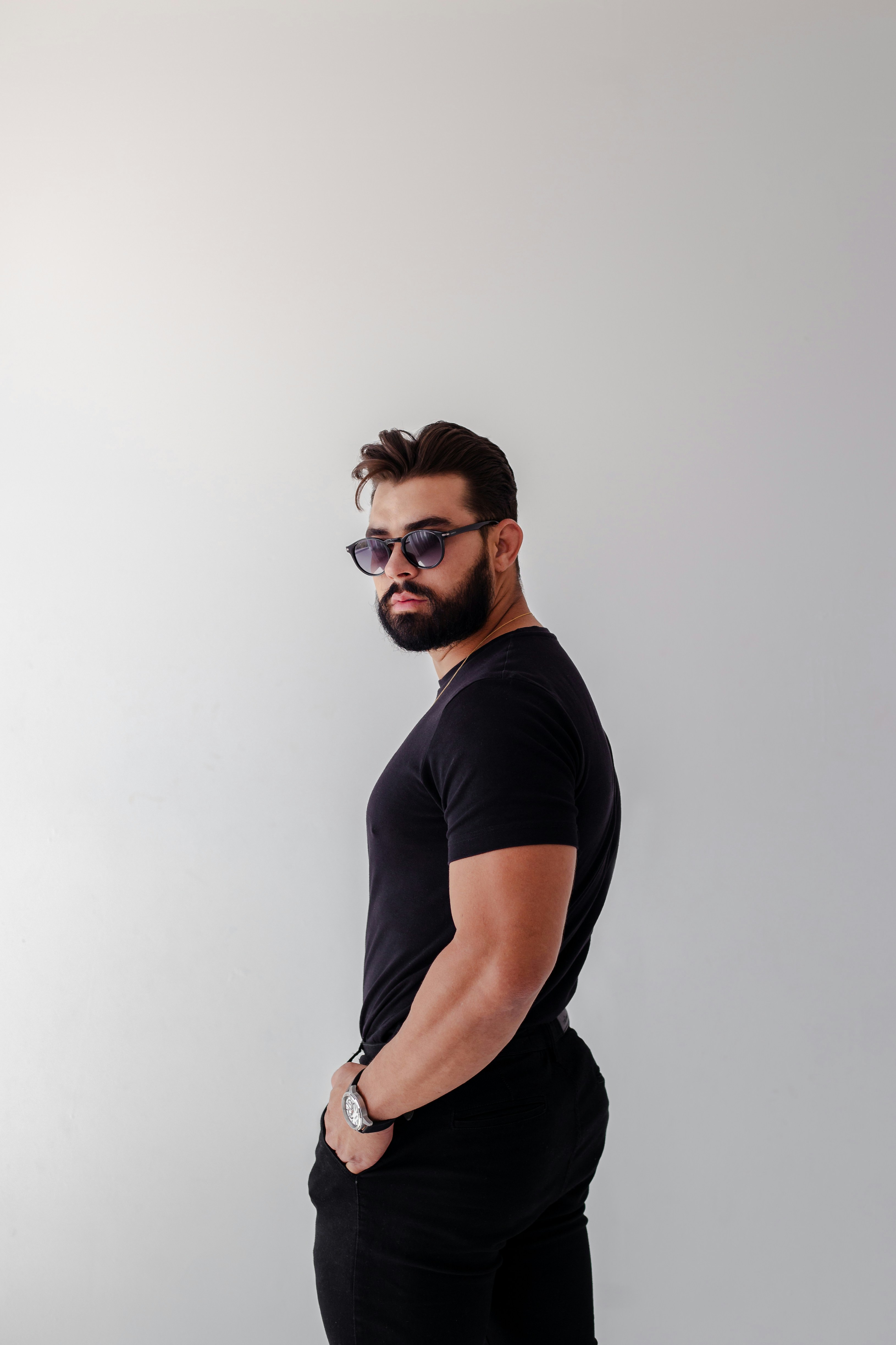Silhouetted Confidence: A Man in Black Against a Minimal Backdrop