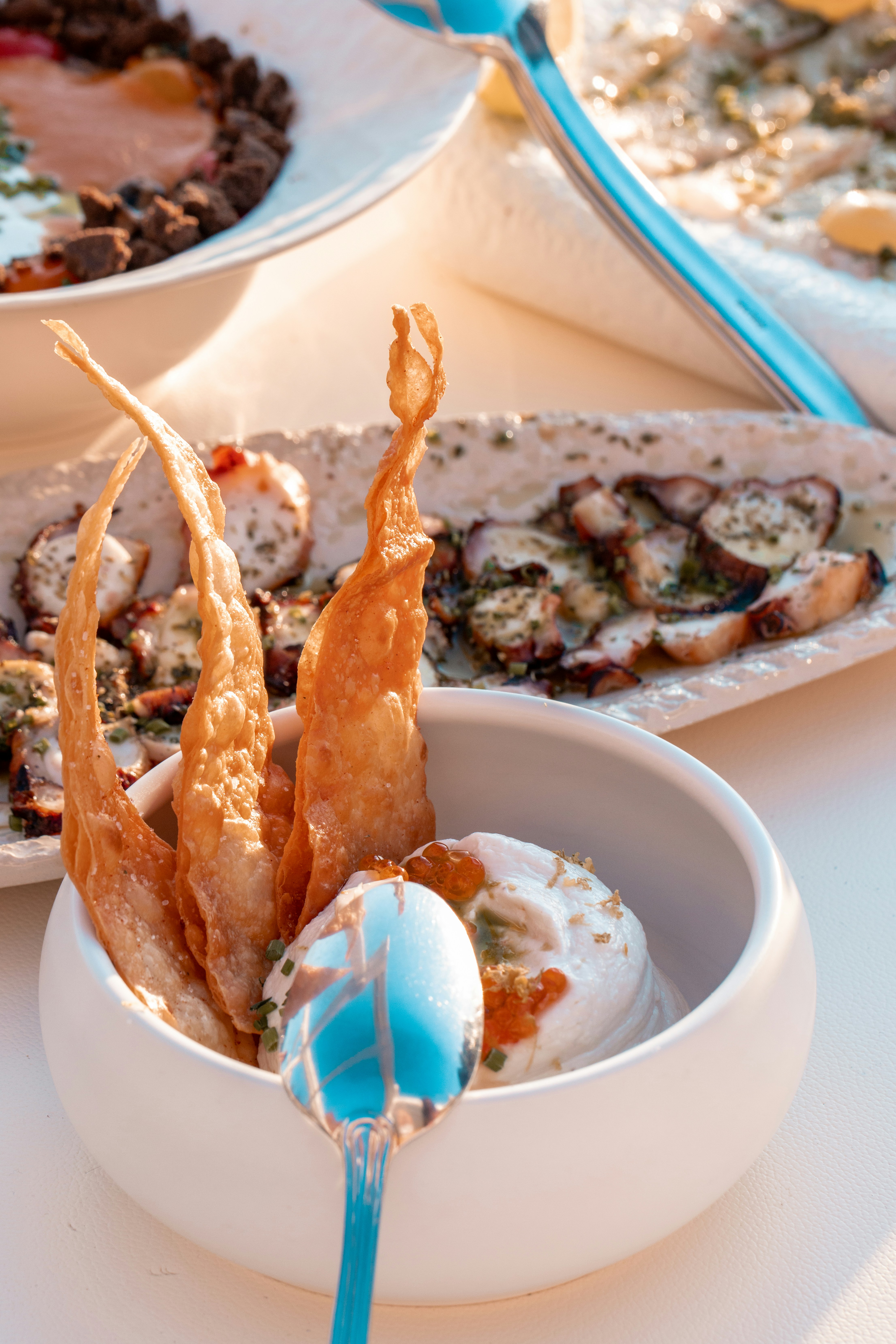 Citrus cream and crispy gossamer pastries with a blue-accented dessert spoon