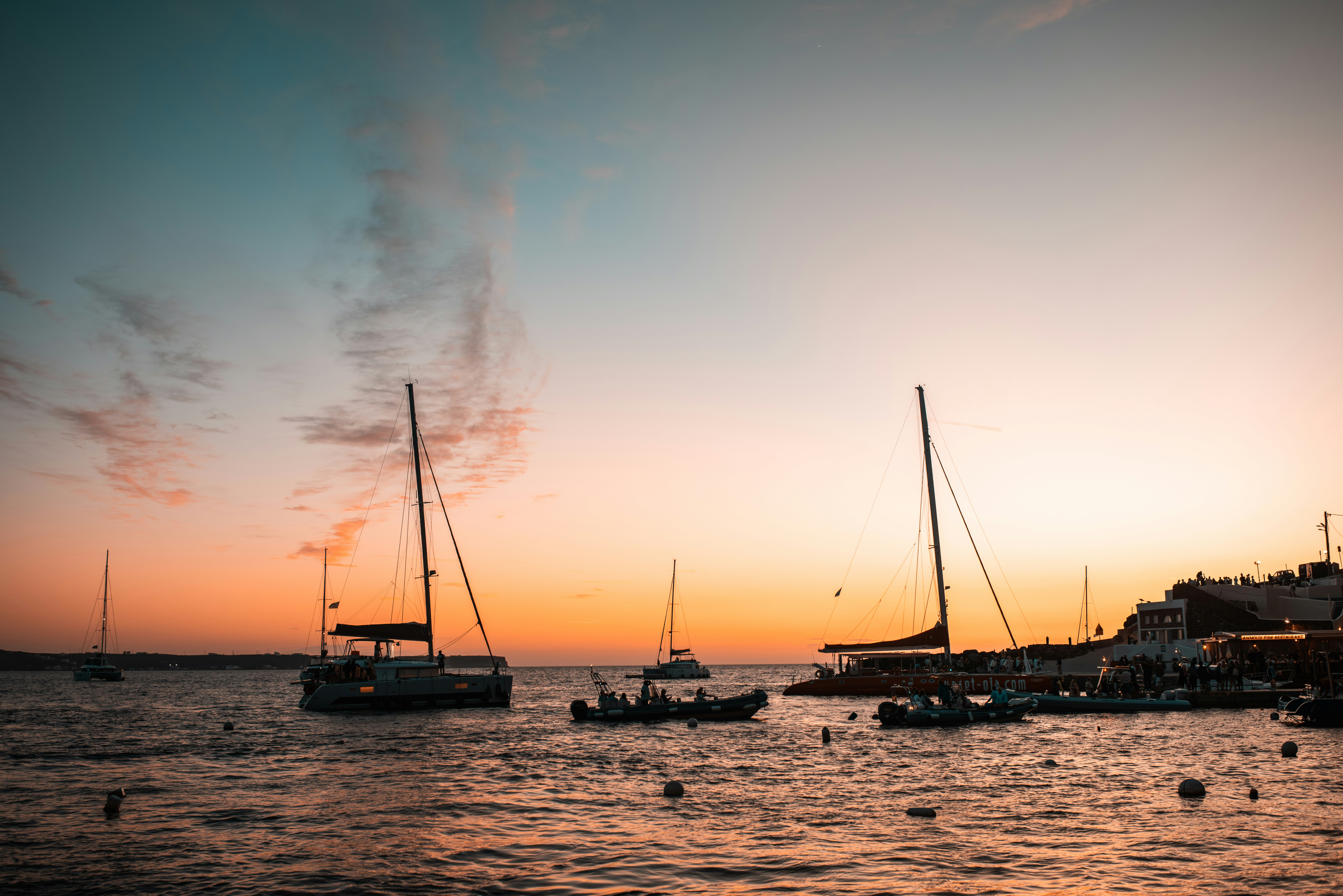 Dusk Harbor: Sails Silhouetted Against the Quiet Sea