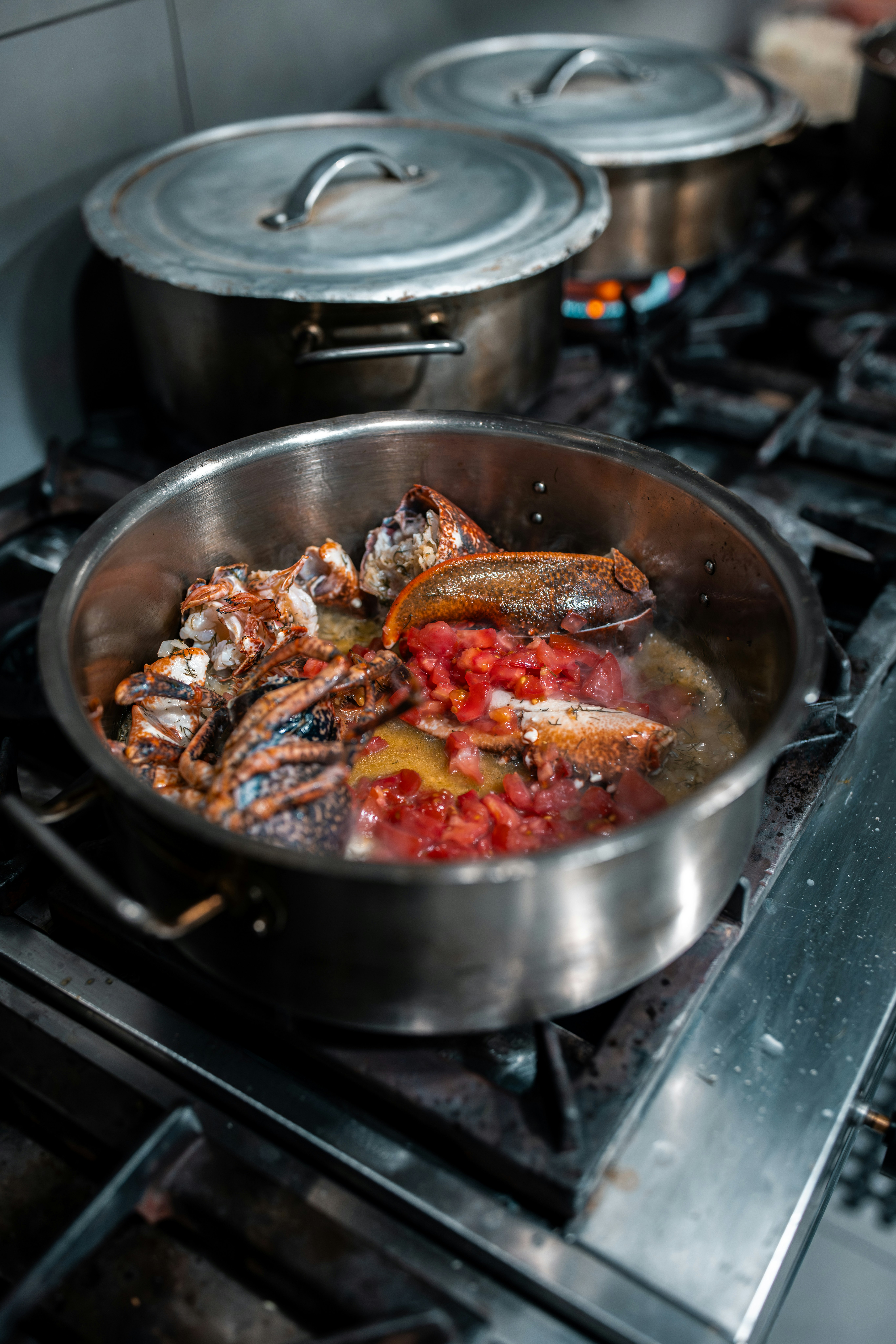 Simmering Pot: Ruby Tomatoes and Crispy Belly in a Stainless Steel Kettle