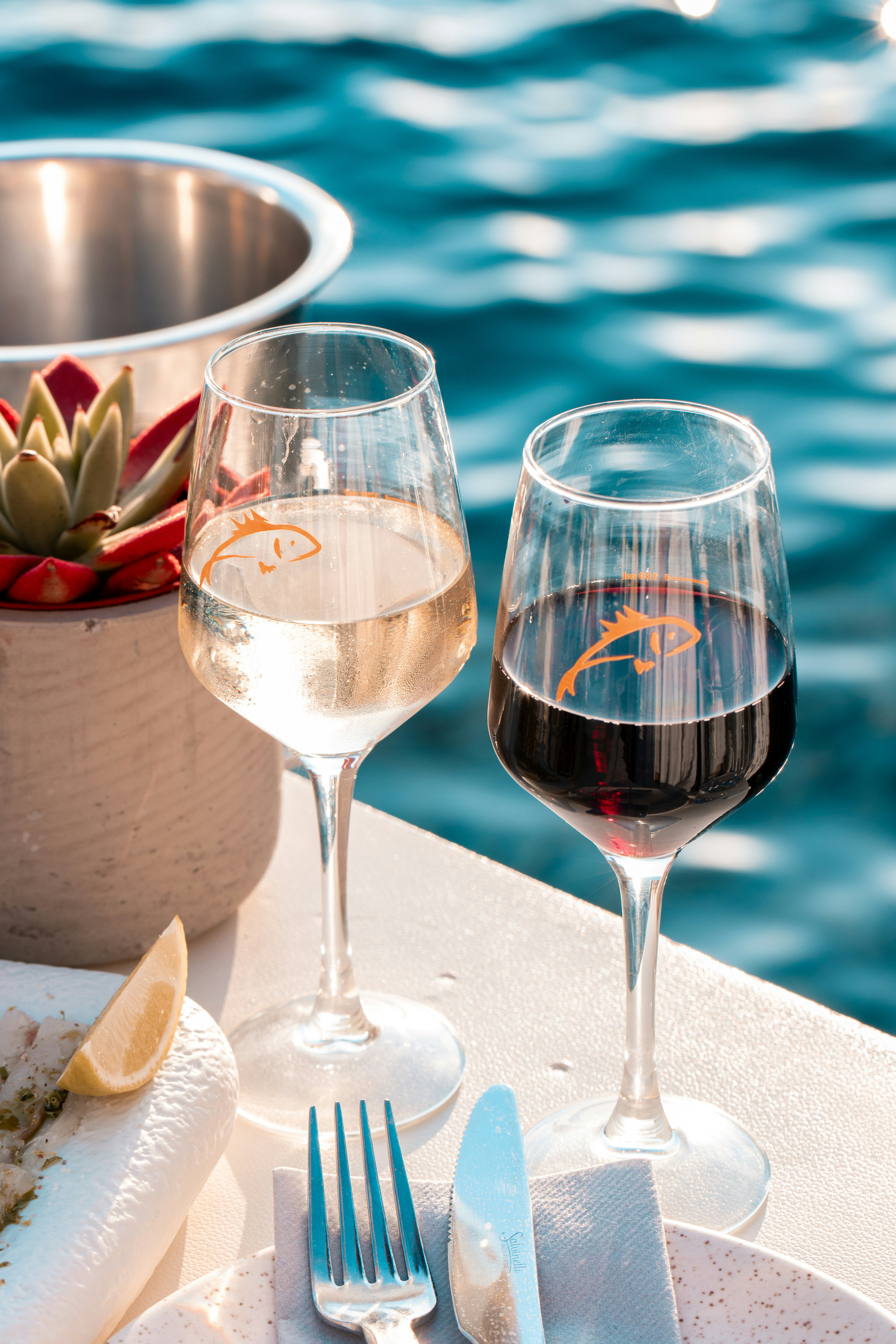 Sunlit Toast: Two Wine Glasses by a Captain’s Table
