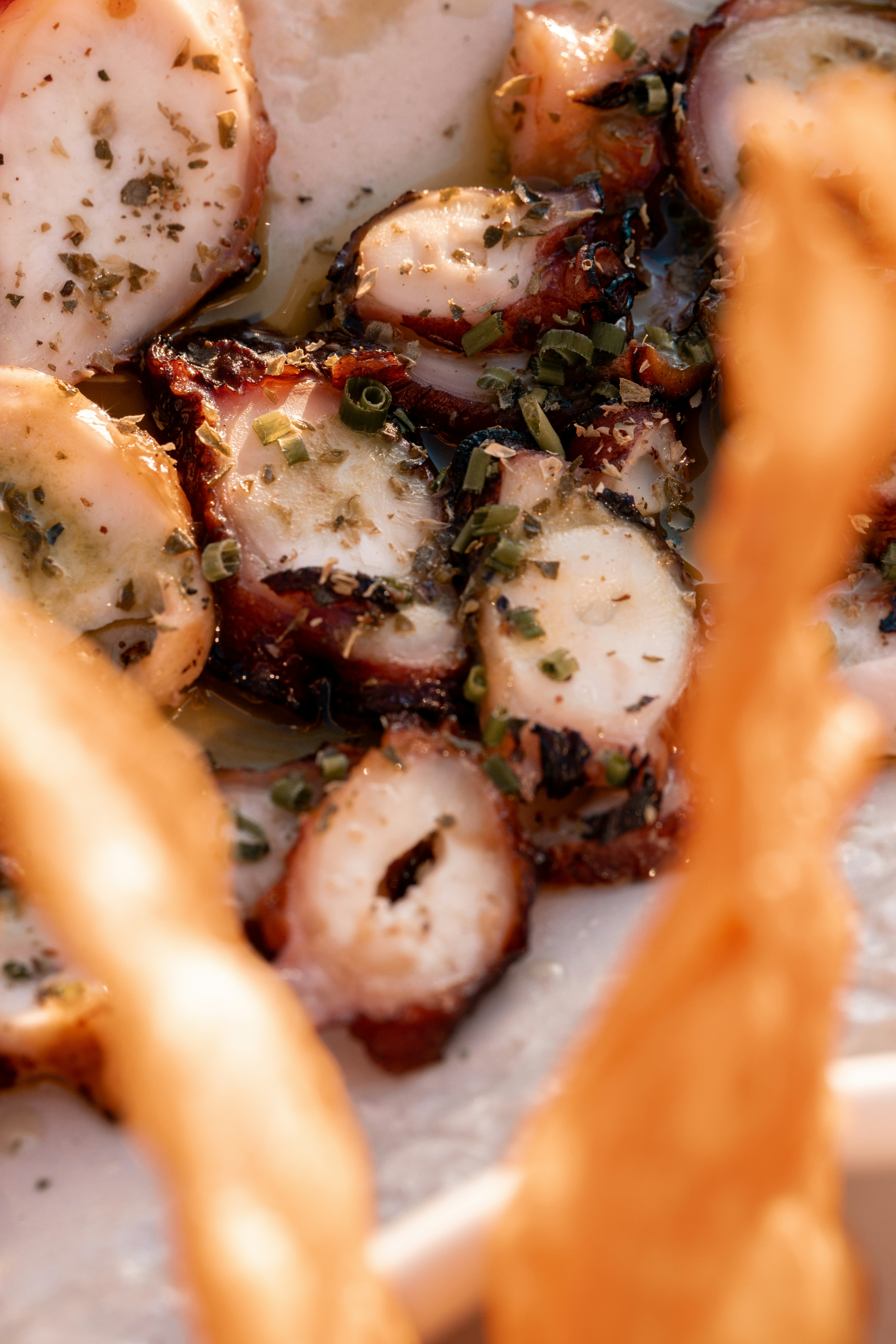 Herb-Gold Slices: Crispy Octopus Charms on a Plate