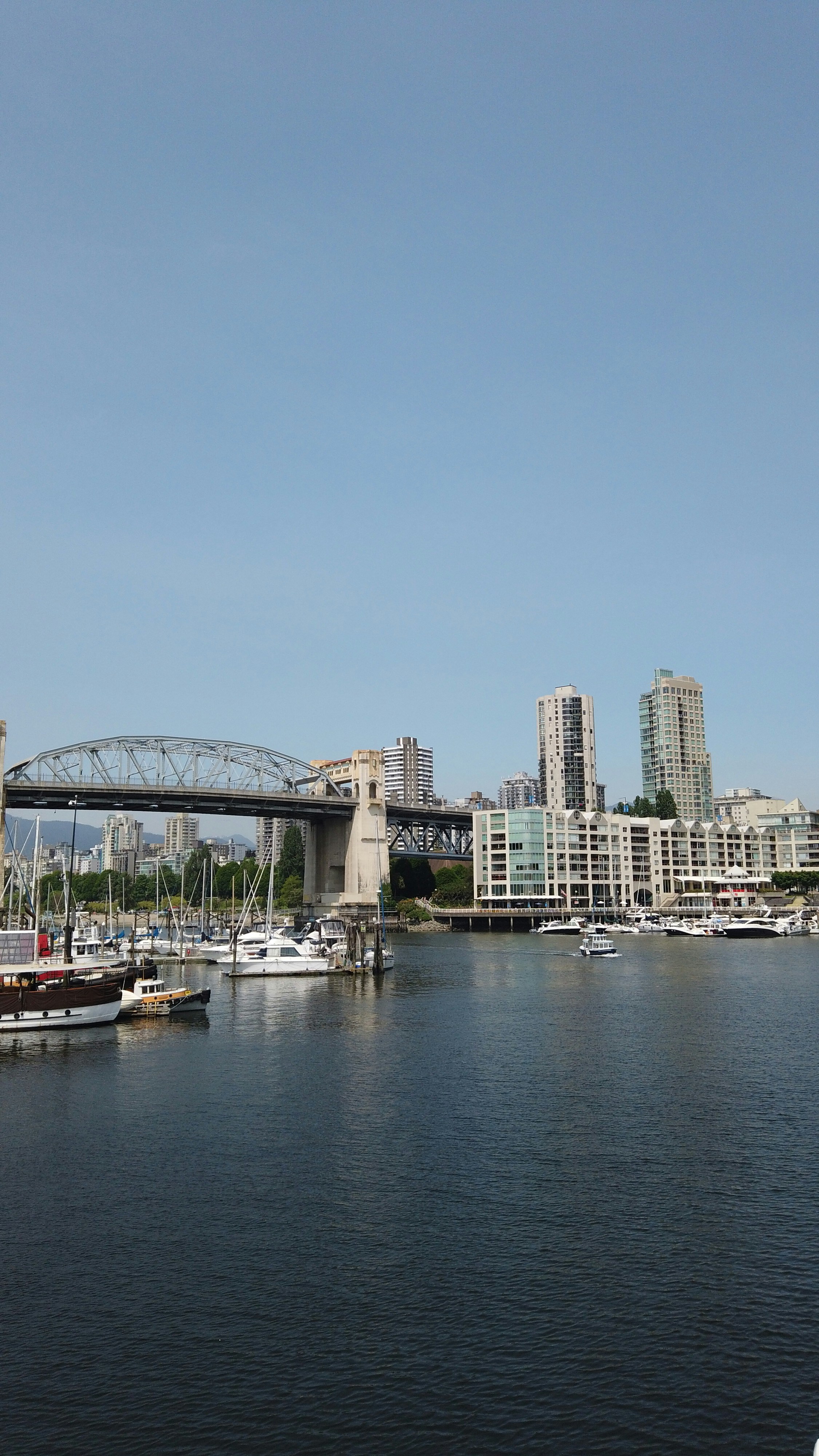 Waterfront Cityscape: A Quiet Harbor Under a Clear Sky
