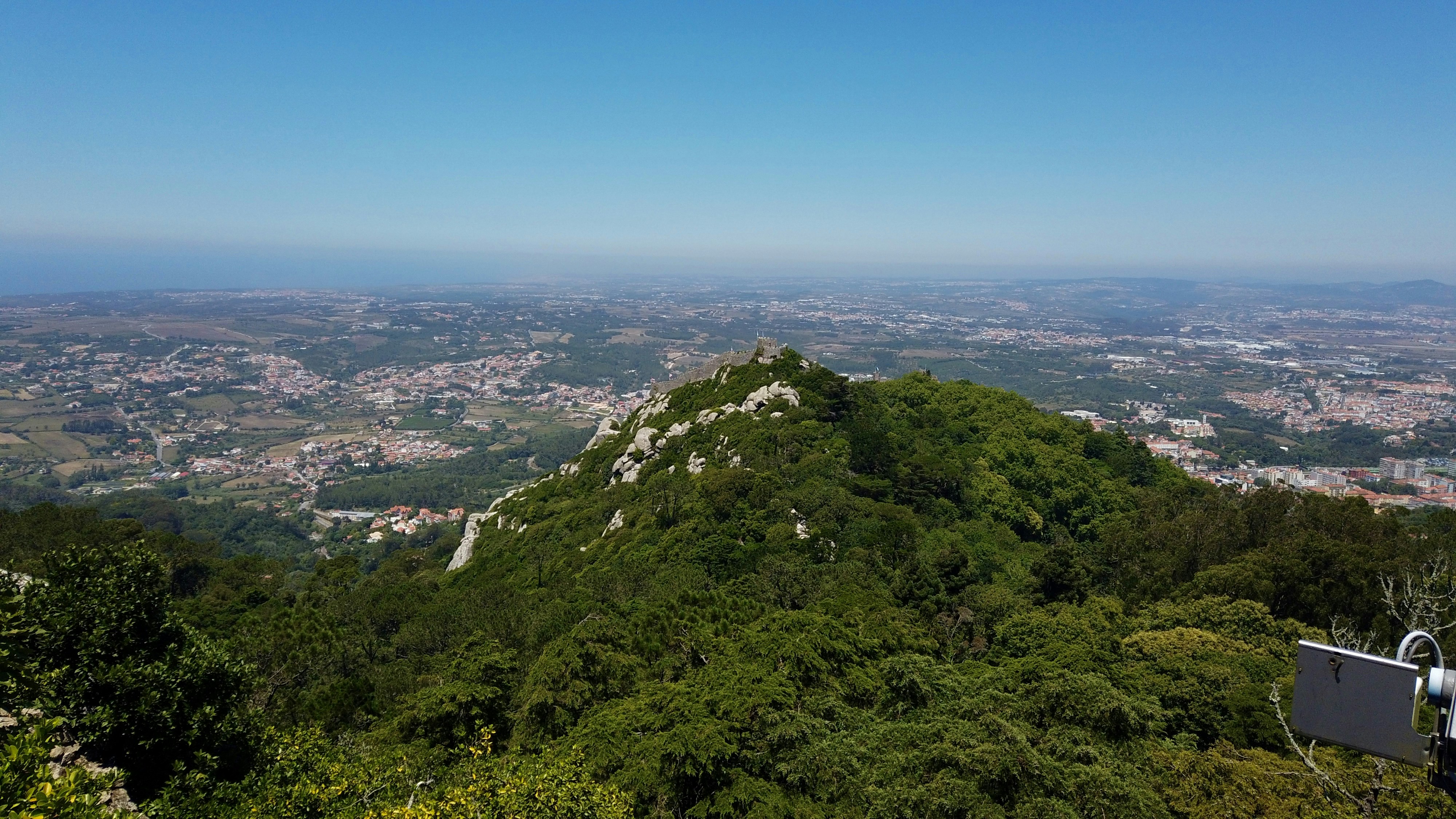 Hilltop Overlook: A Quiet Coastal City Sprawl Beneath a Clear Horizon