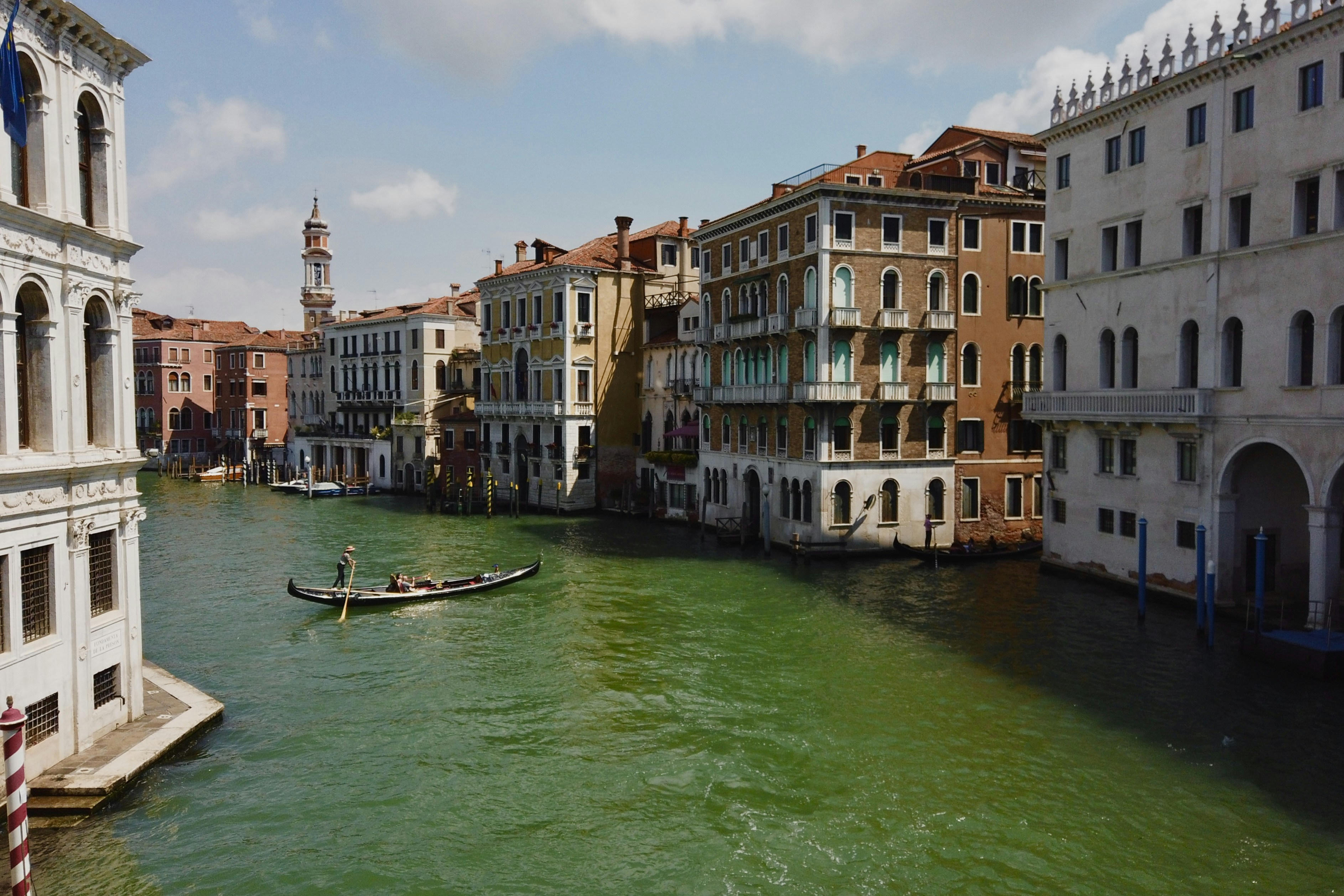 Canal Symphony: Gondola Glide Past Venetian Facades