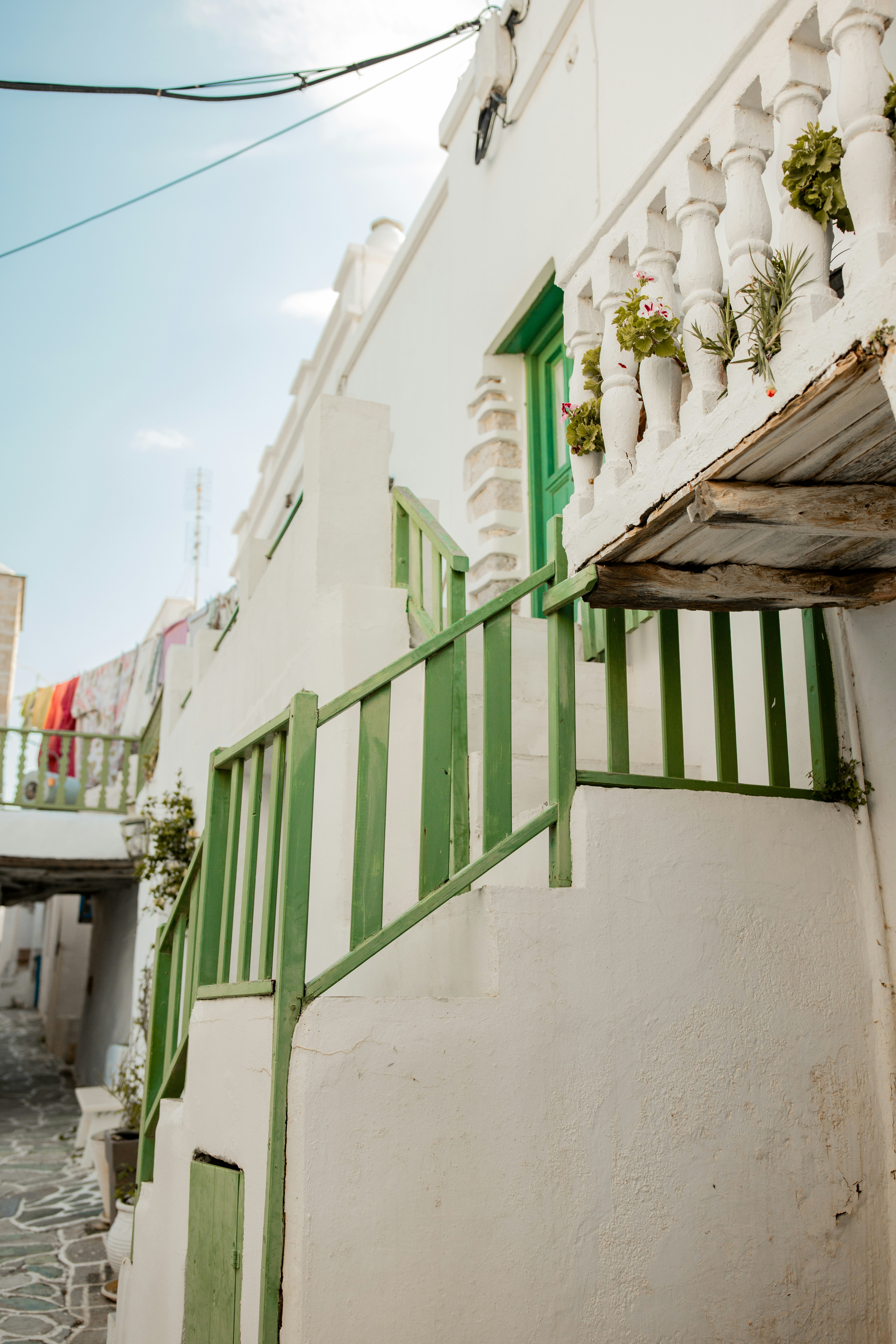 Sunlit Mediterranean Staircase with Green Accents