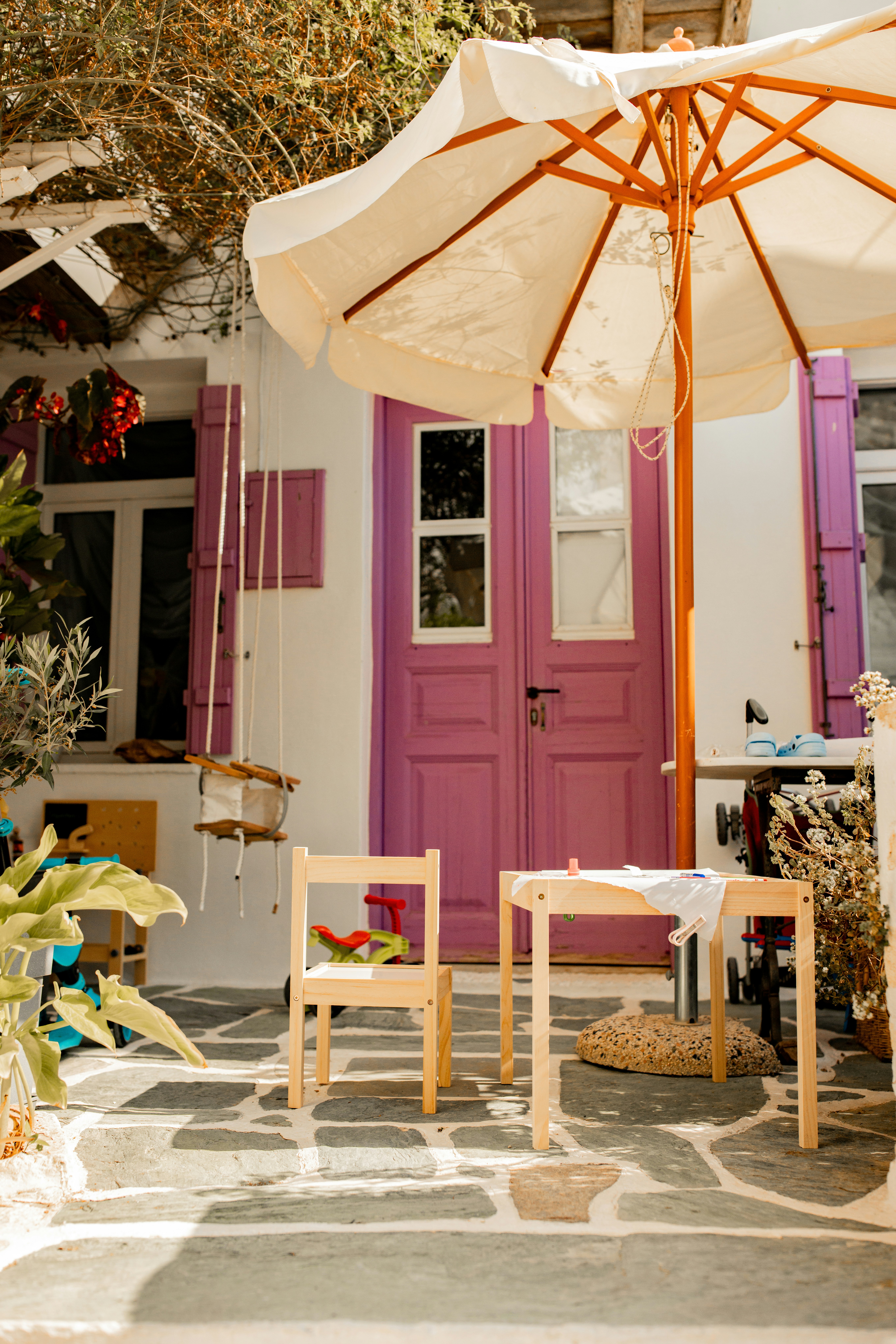 Sunlit Courtyard with Lavender Doors and Patio Table