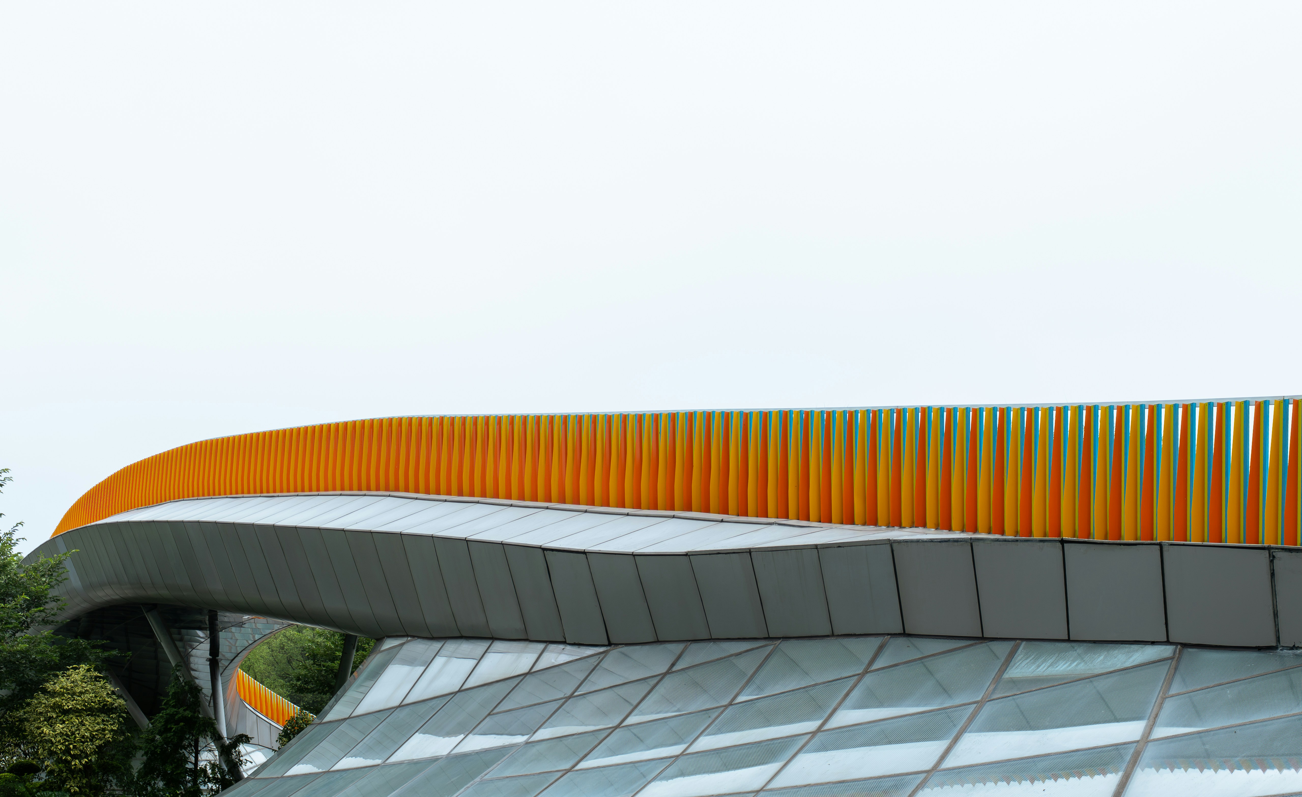 Curved orange ribbon over modern glass canopy