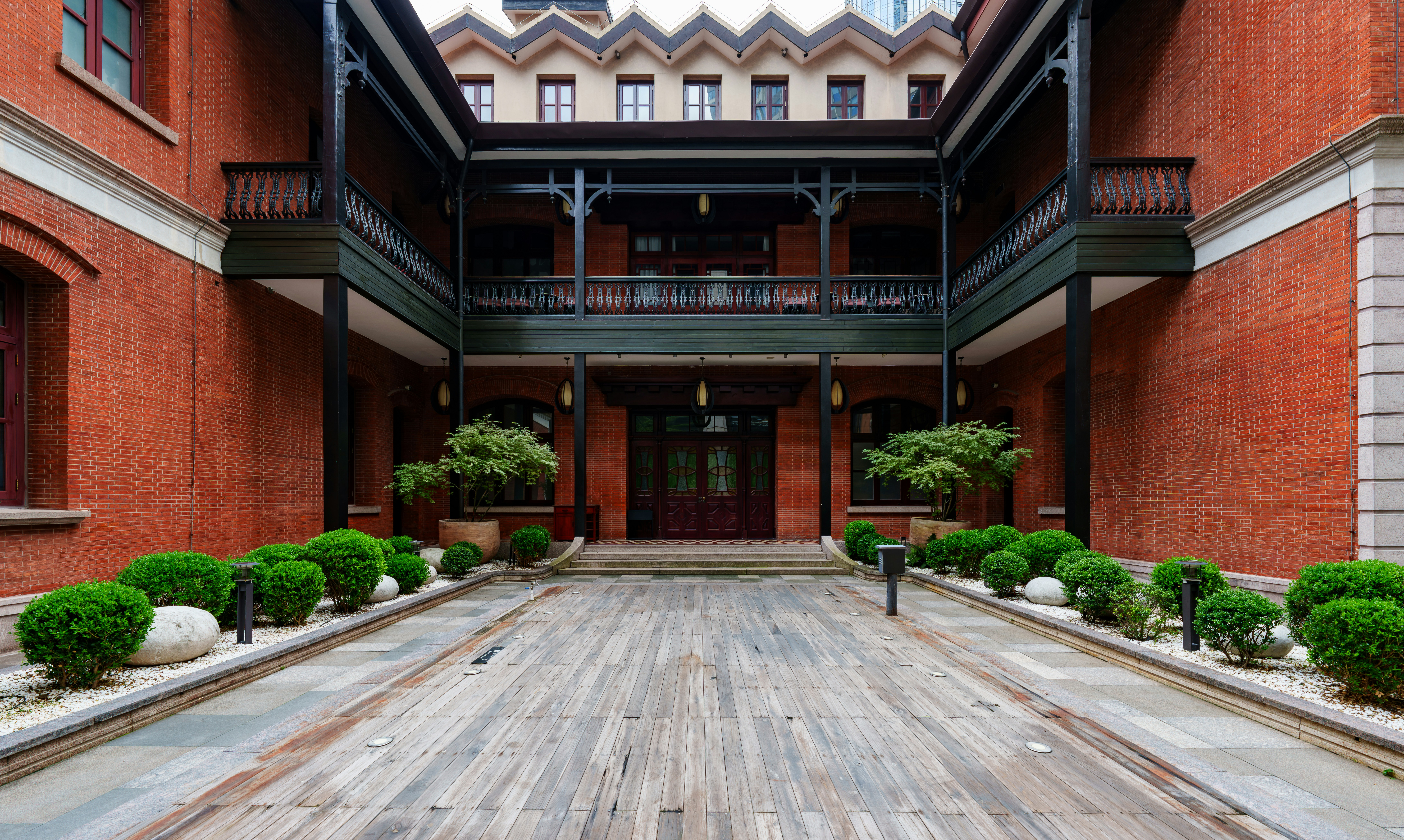 Atrium Approach: Red Brick Courtyard with Central Pathway