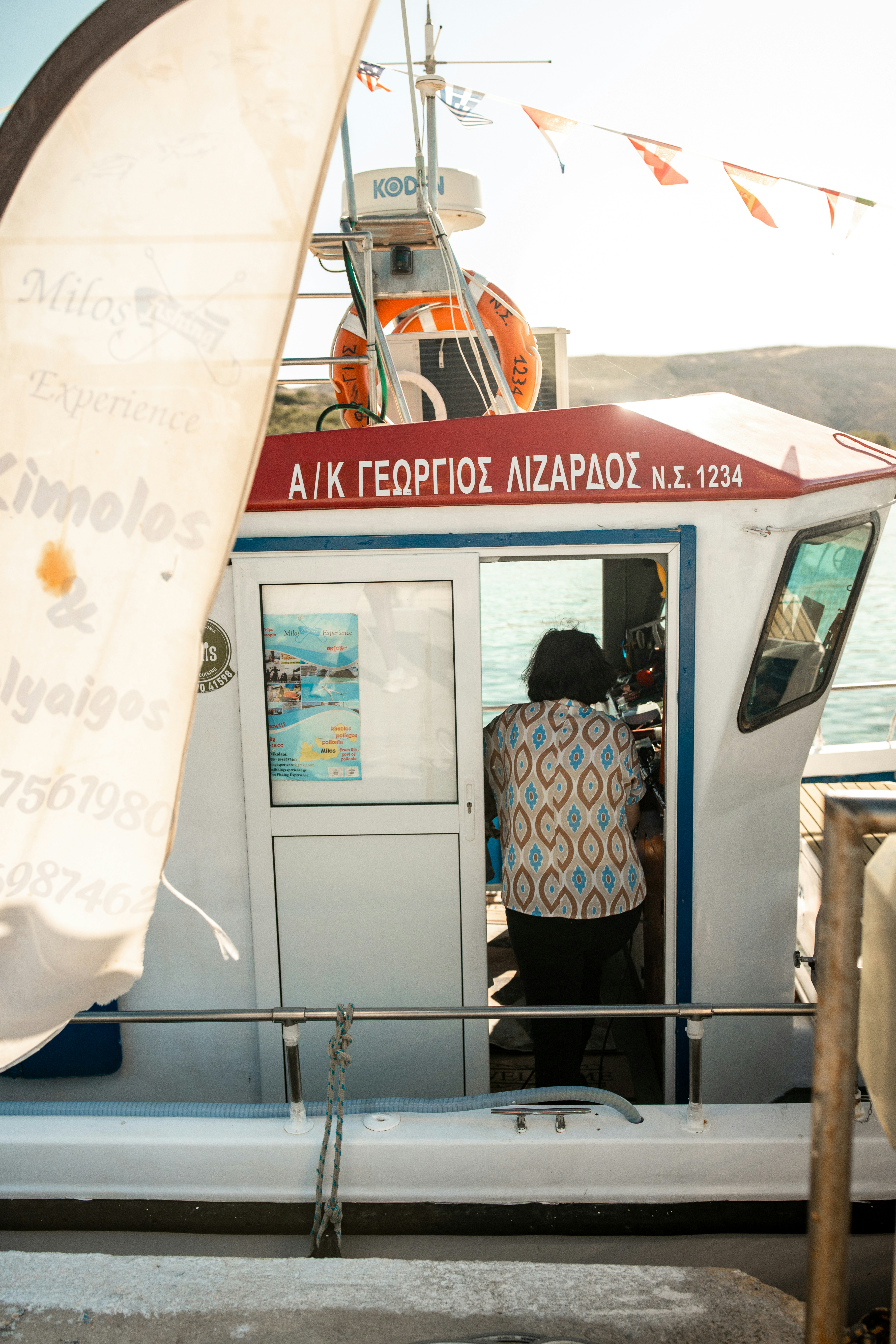 Crew Member Entering a Compact Boat Cabin by the Harbor
