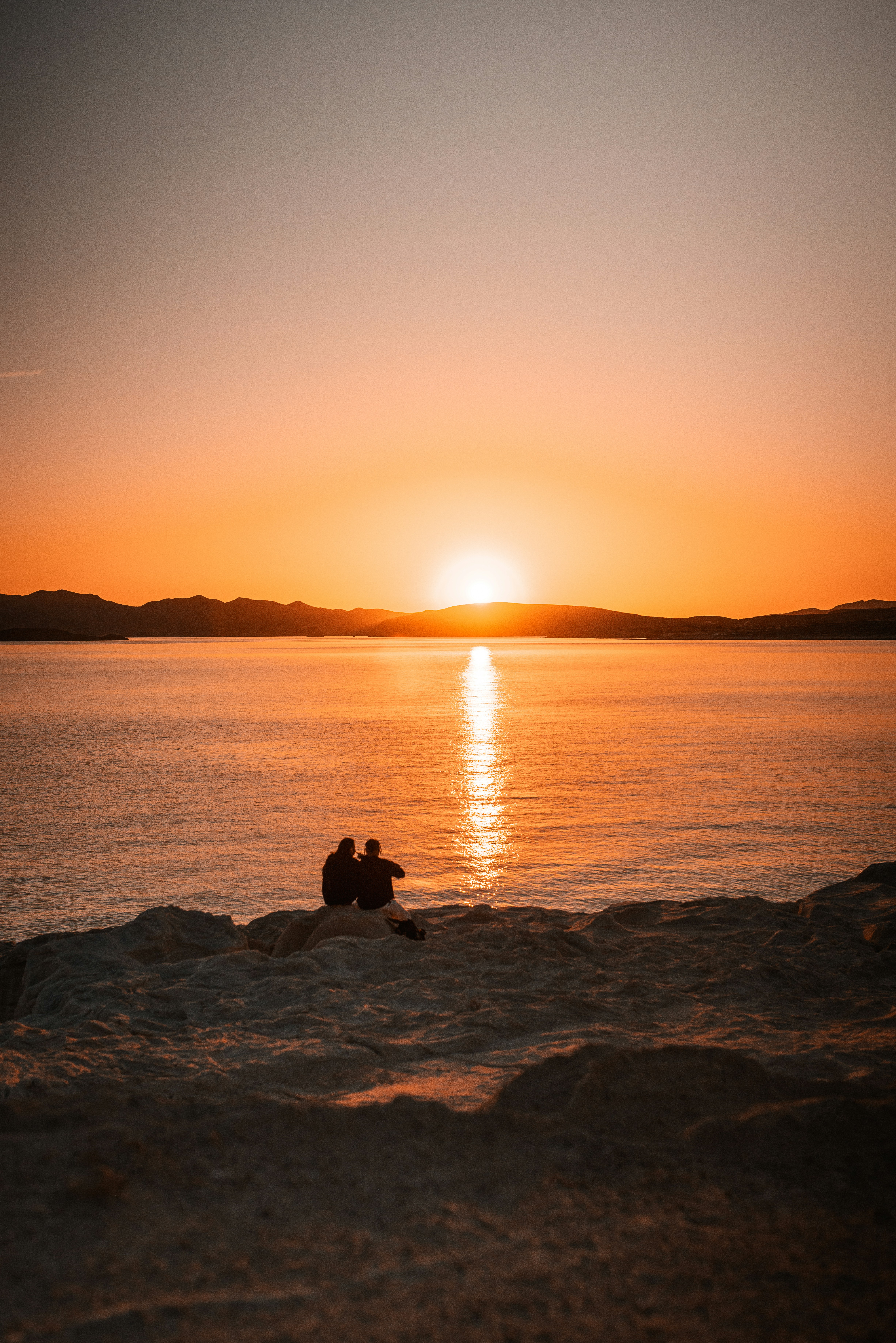 Sunset by the Silent Shore: A Couple at Dusk