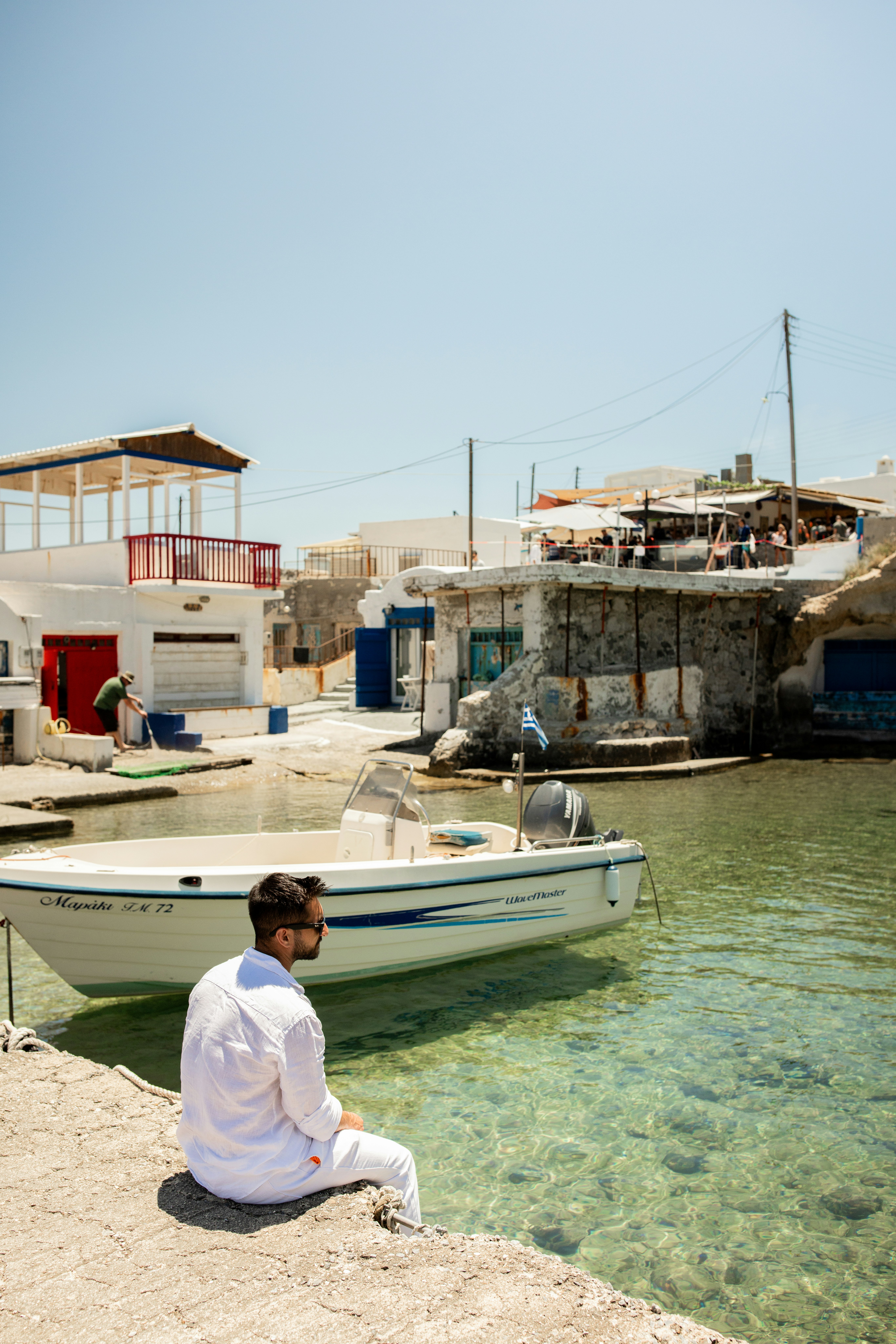 Harbor Quietude: A Seated Figure by Clear Waters