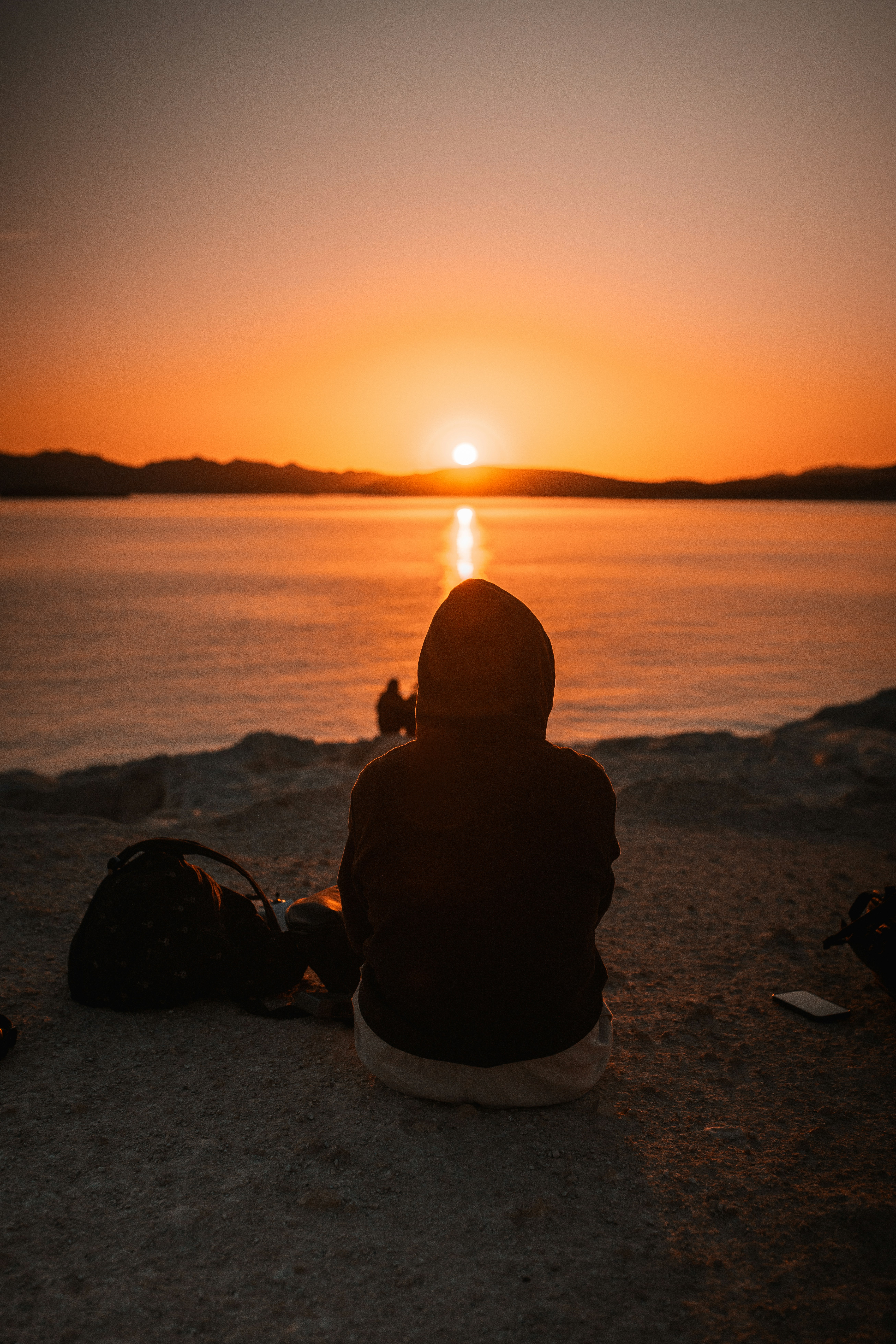 Horizon Seated: A Quiet Sunset with a Hooded Figure