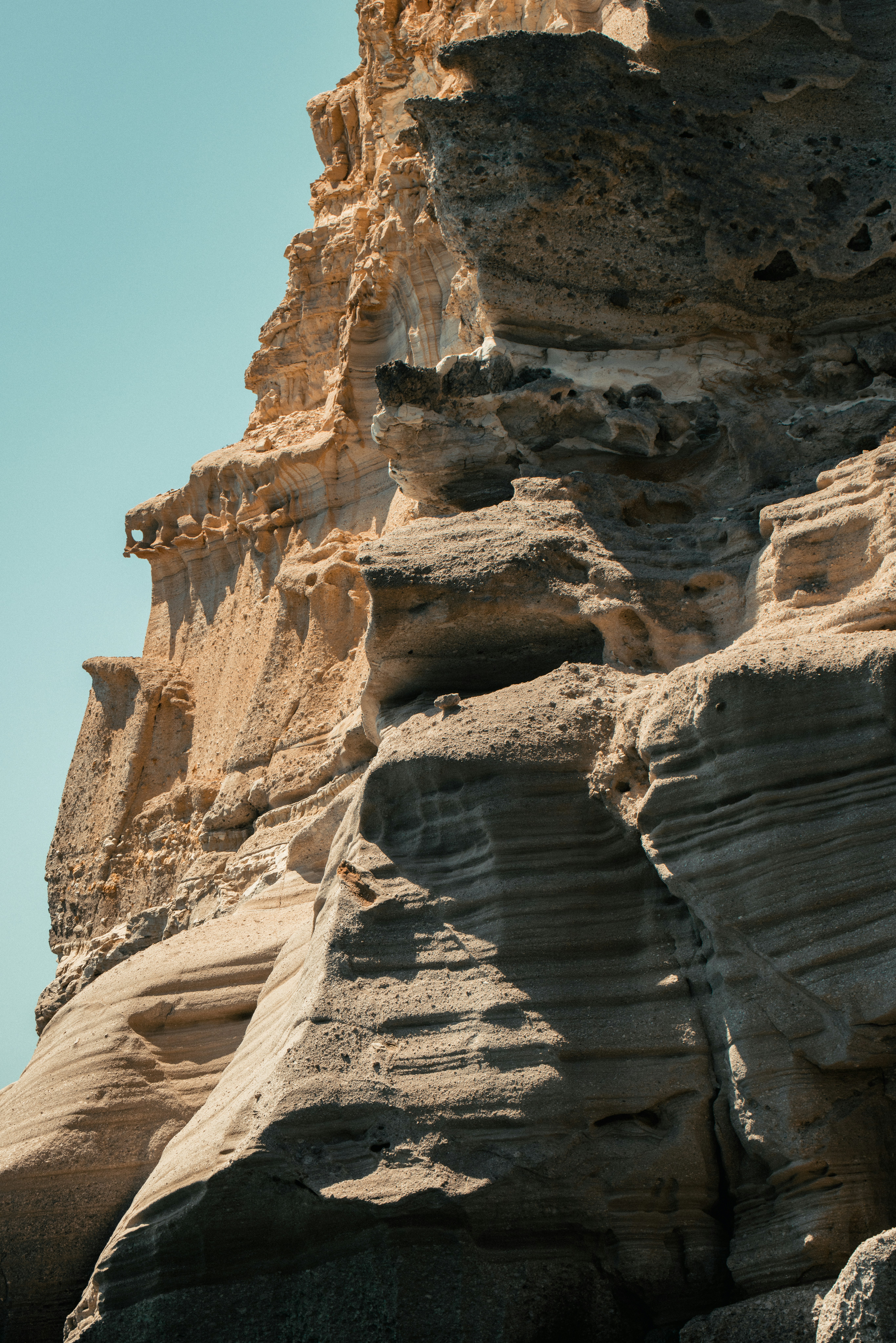 Strata Portrait: Weathered Cliff Faces in Soft Sunlight