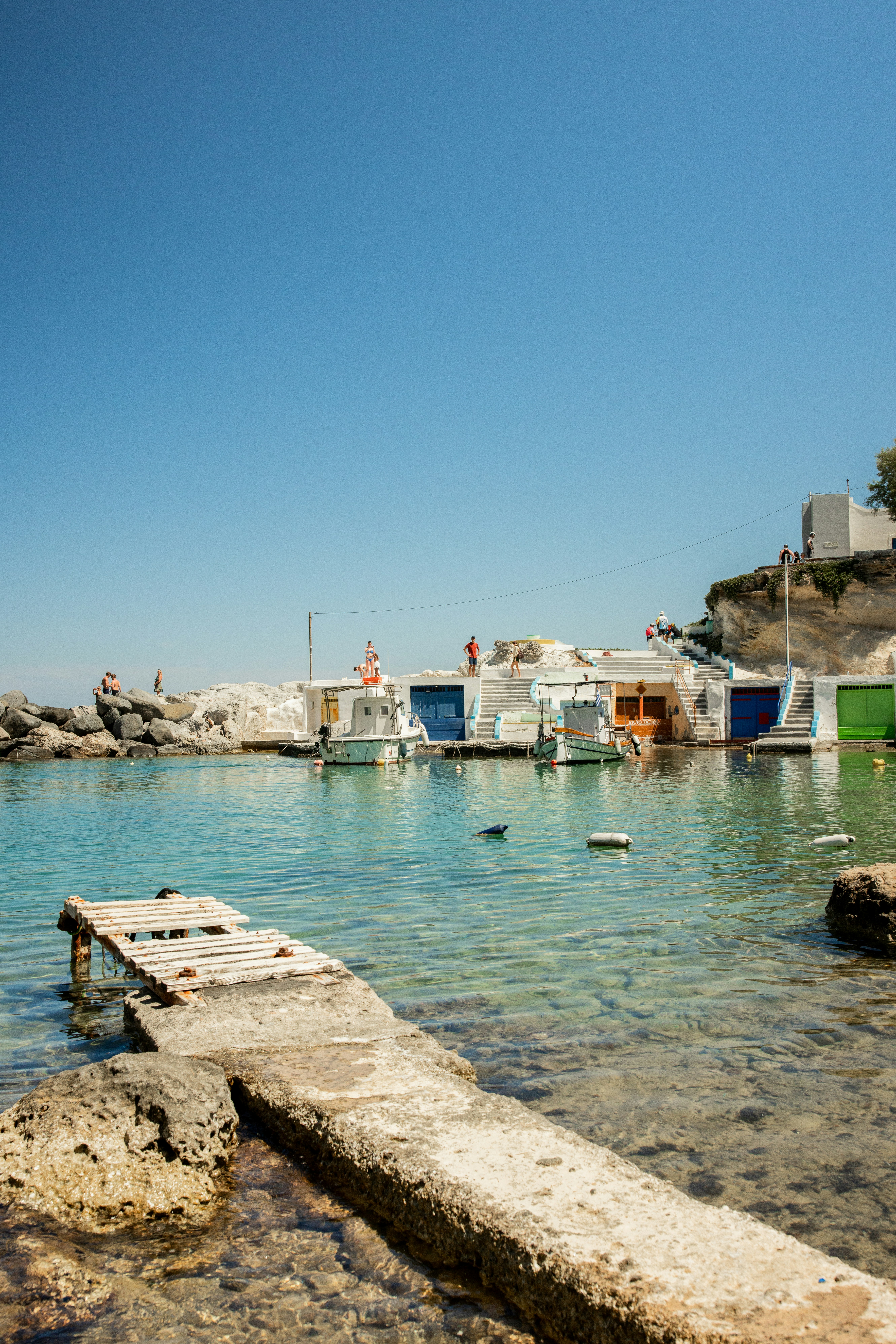 Emerald Shoreline: Boats, Steps, and Sea Light