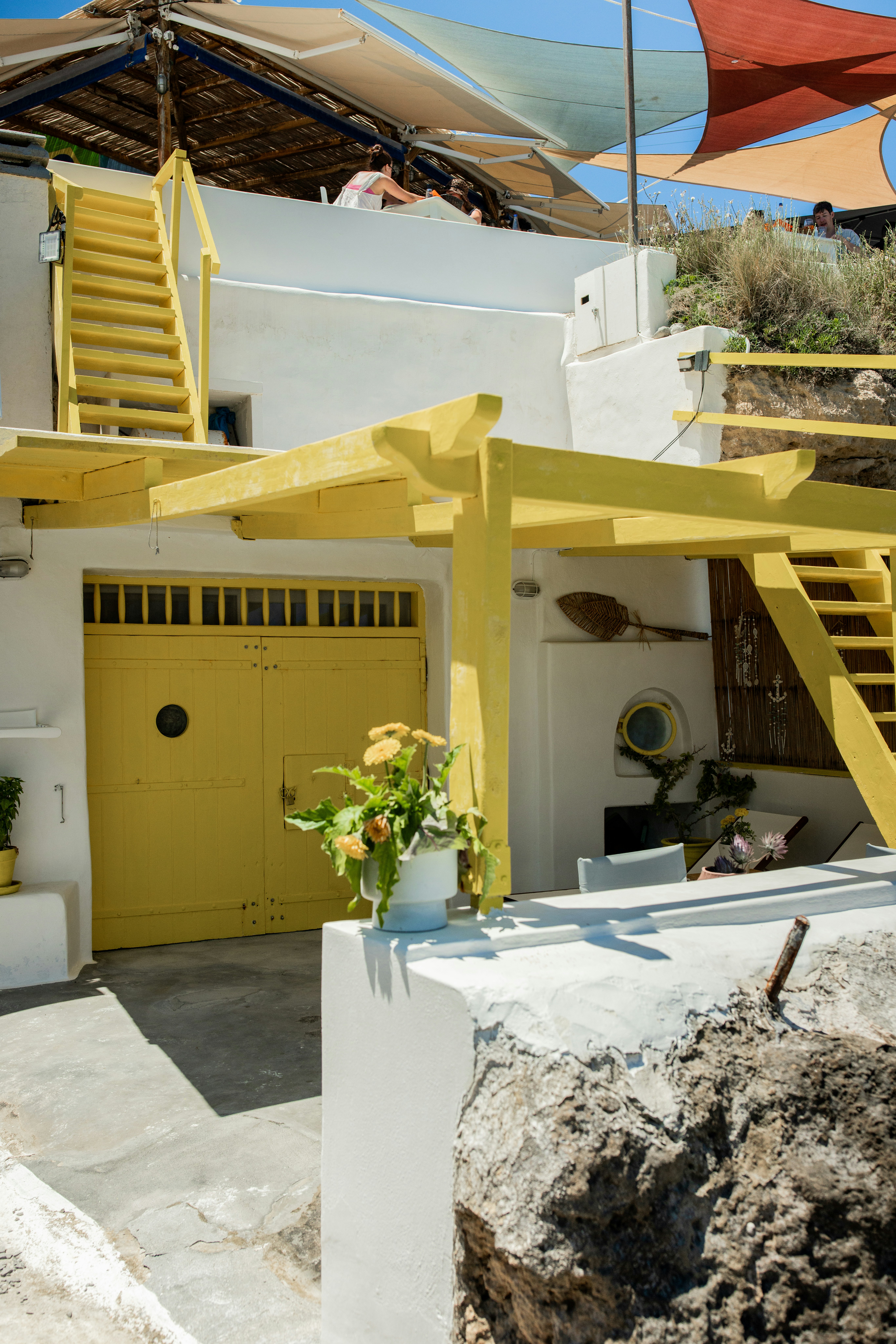 Yellow Staircase and Terraced Hideaway under Colorful Canopies