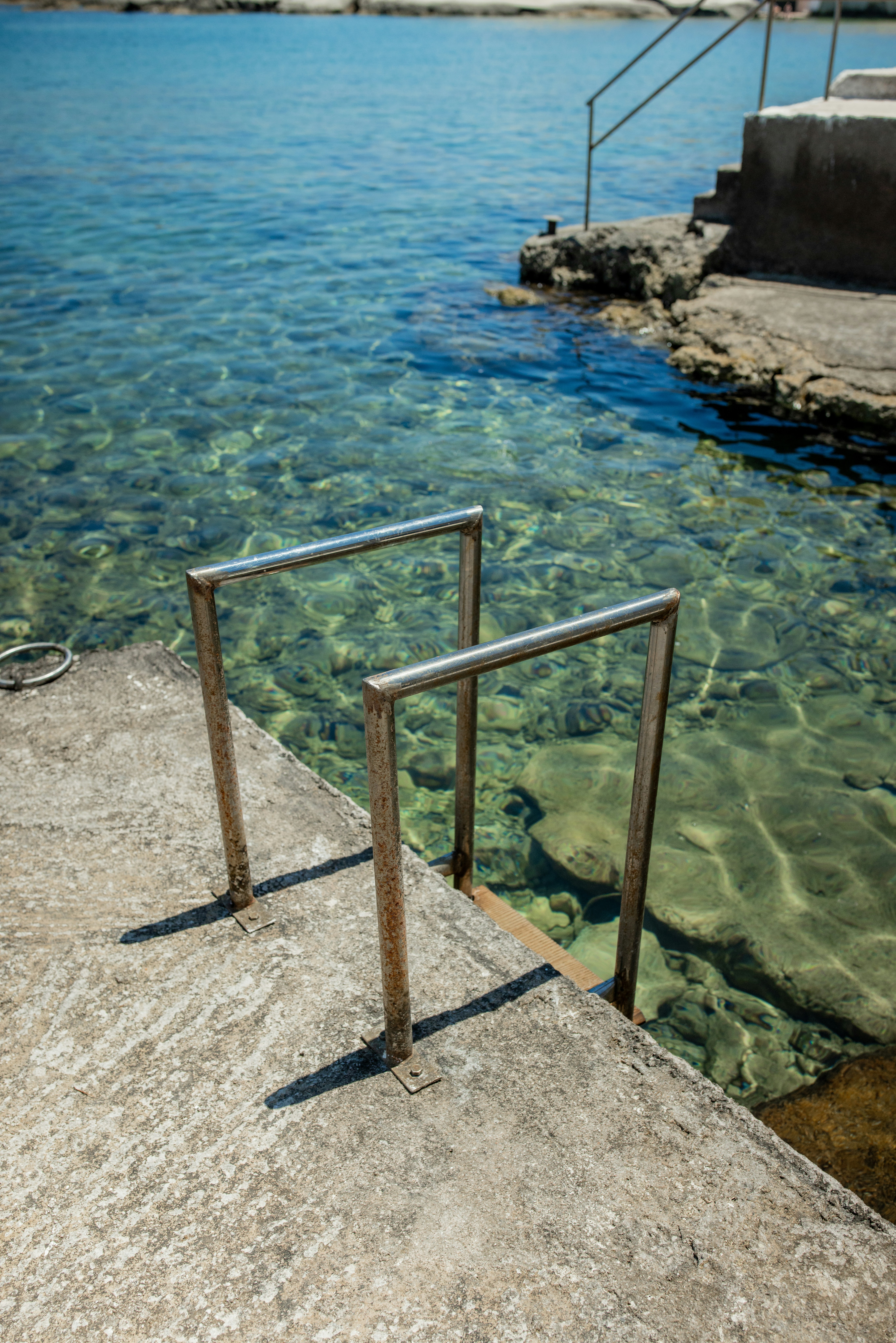 Rusted Rungs by a Turquoise Tidal Edge