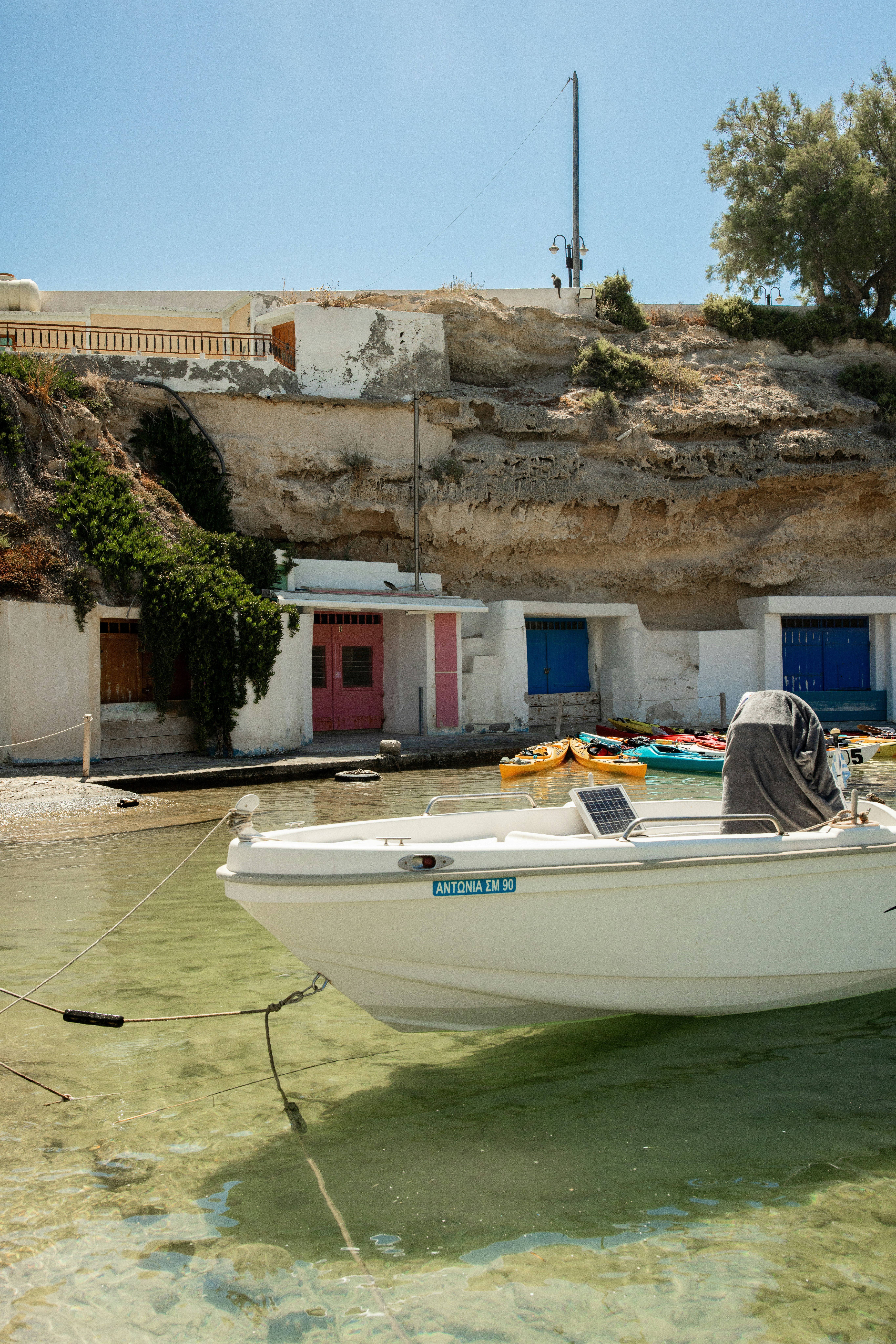 Harborhaus: A Tide of Boats by Verdant Cliffs