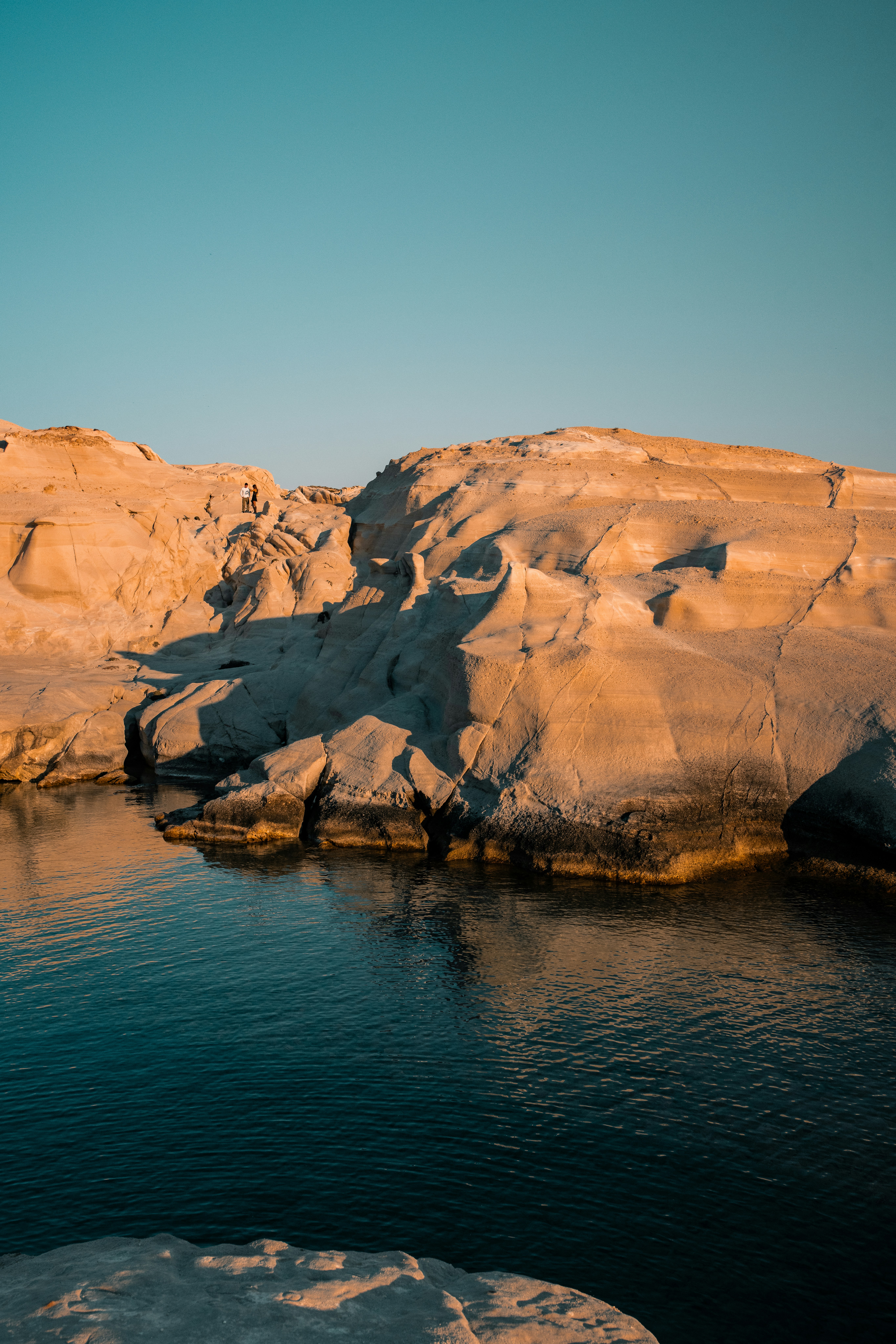 Sunlit Tides: Marble Coastline at Dusk