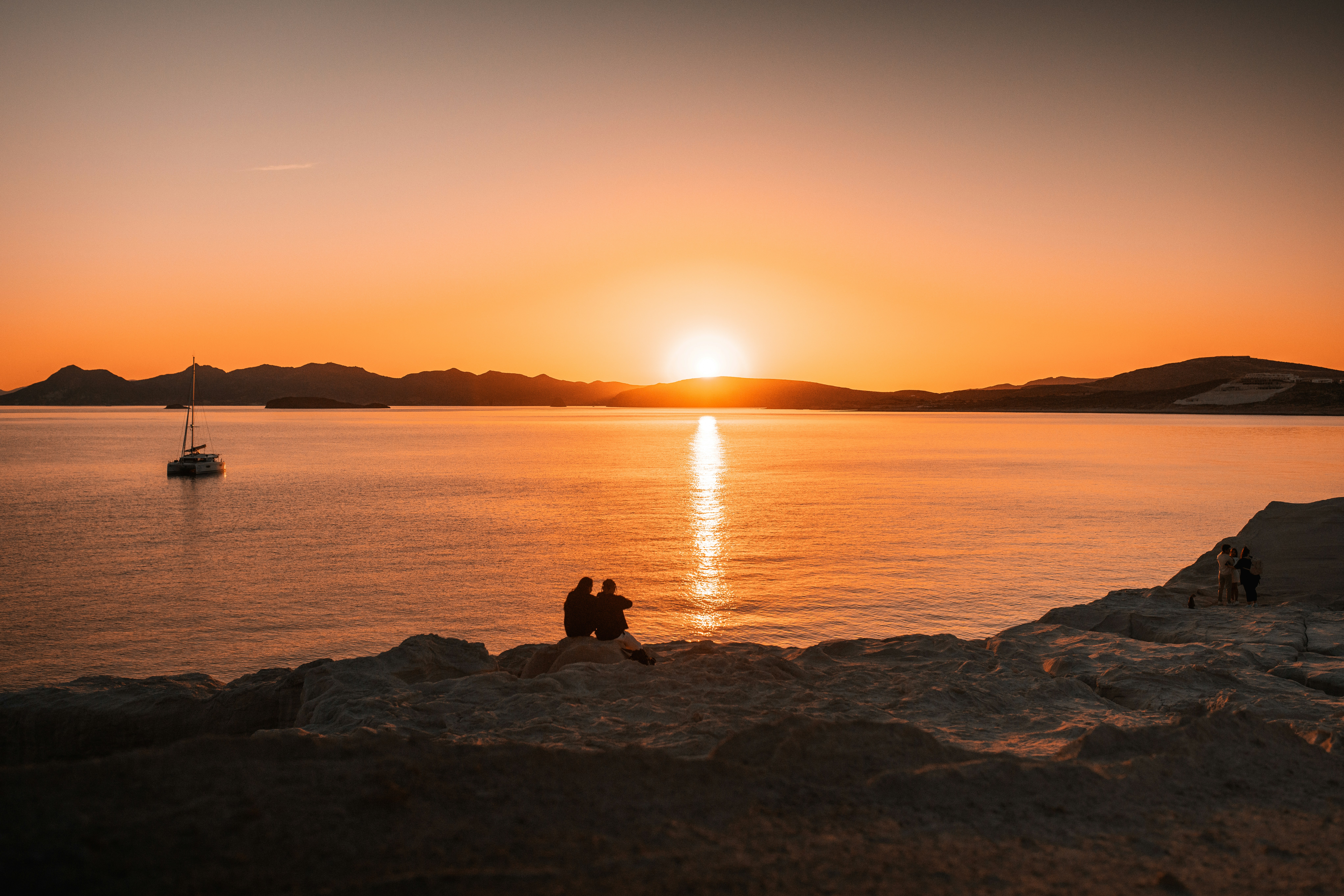 Sunset Embrace on the Rocky Shore