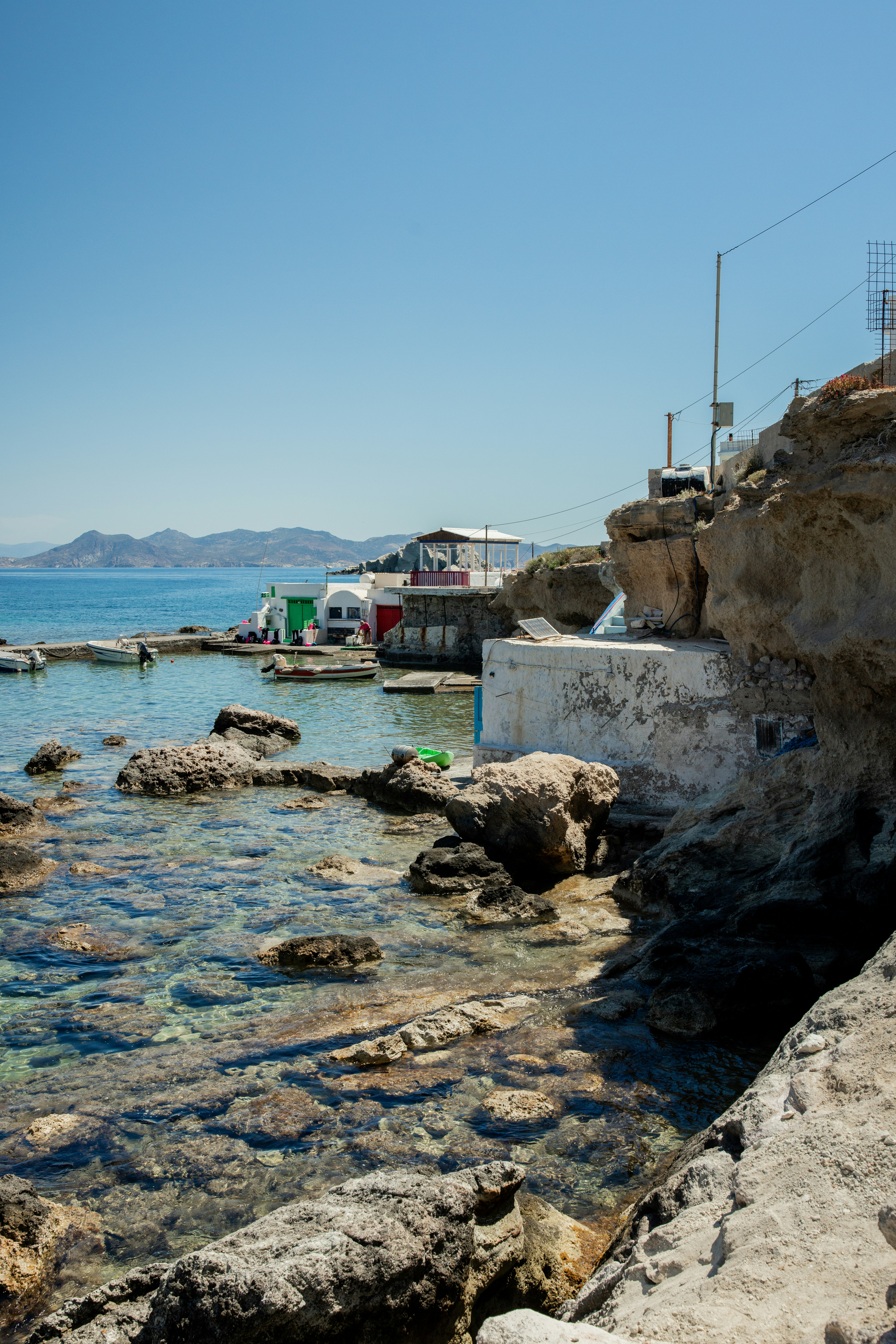 Harbor Edge: Sunlit Rocks and Quiet Docks
