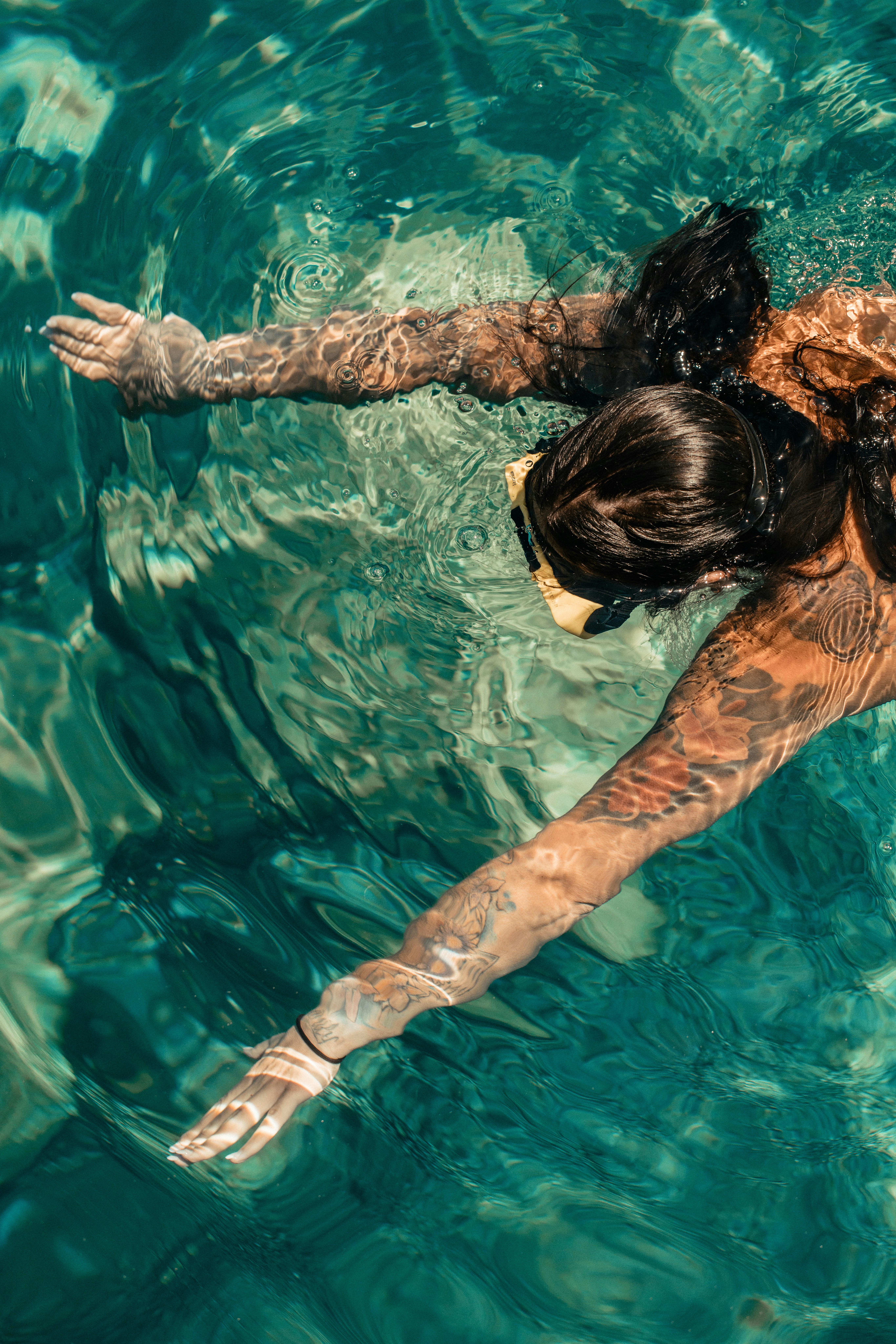 Diving Reach: A Sunlit Silhouette in Turquoise Waters