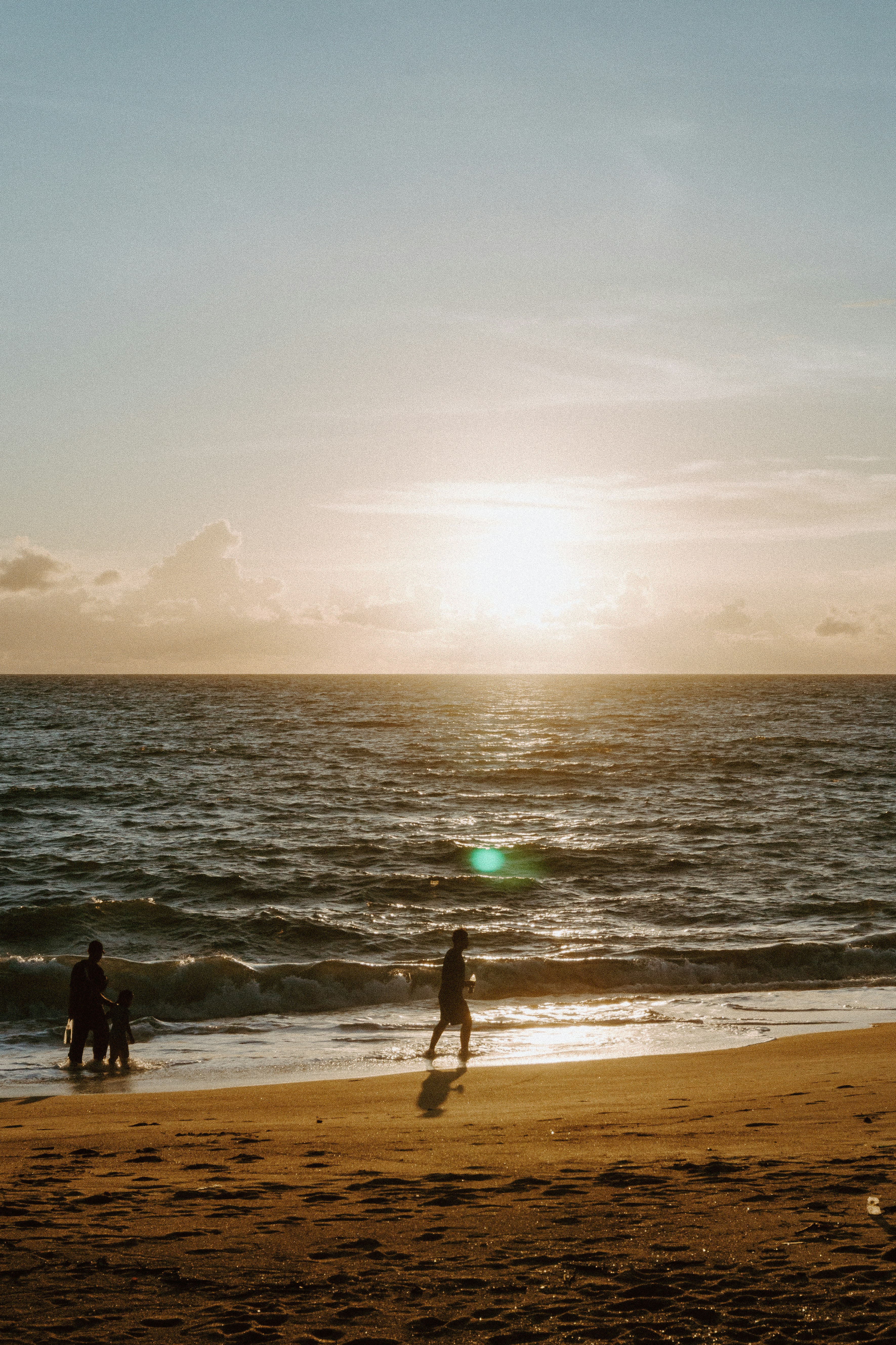 Sunlit shoreline: silhouettes and the quiet parade of waves