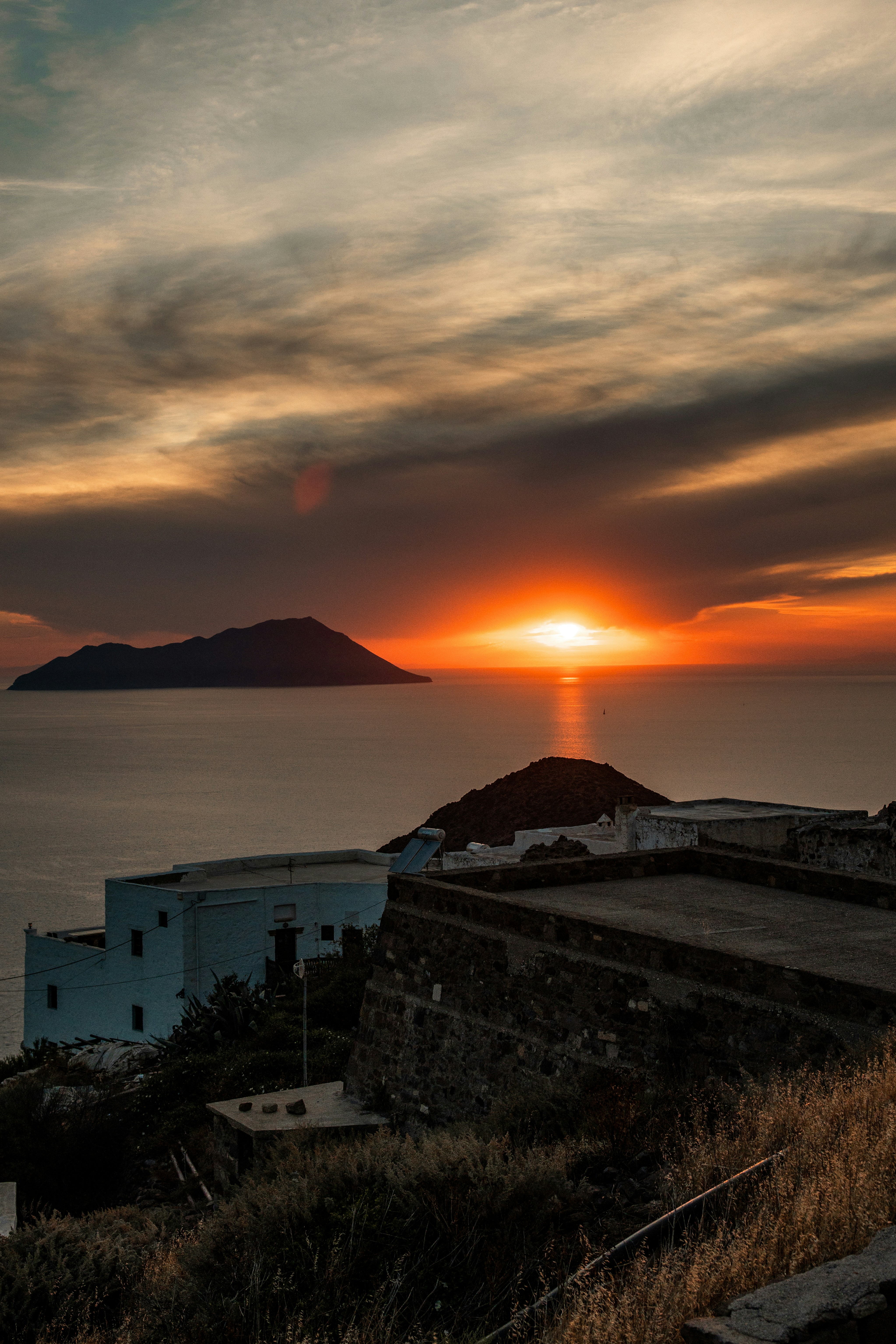 Sunset Over the Citadel: A Coastal Village Silhouette