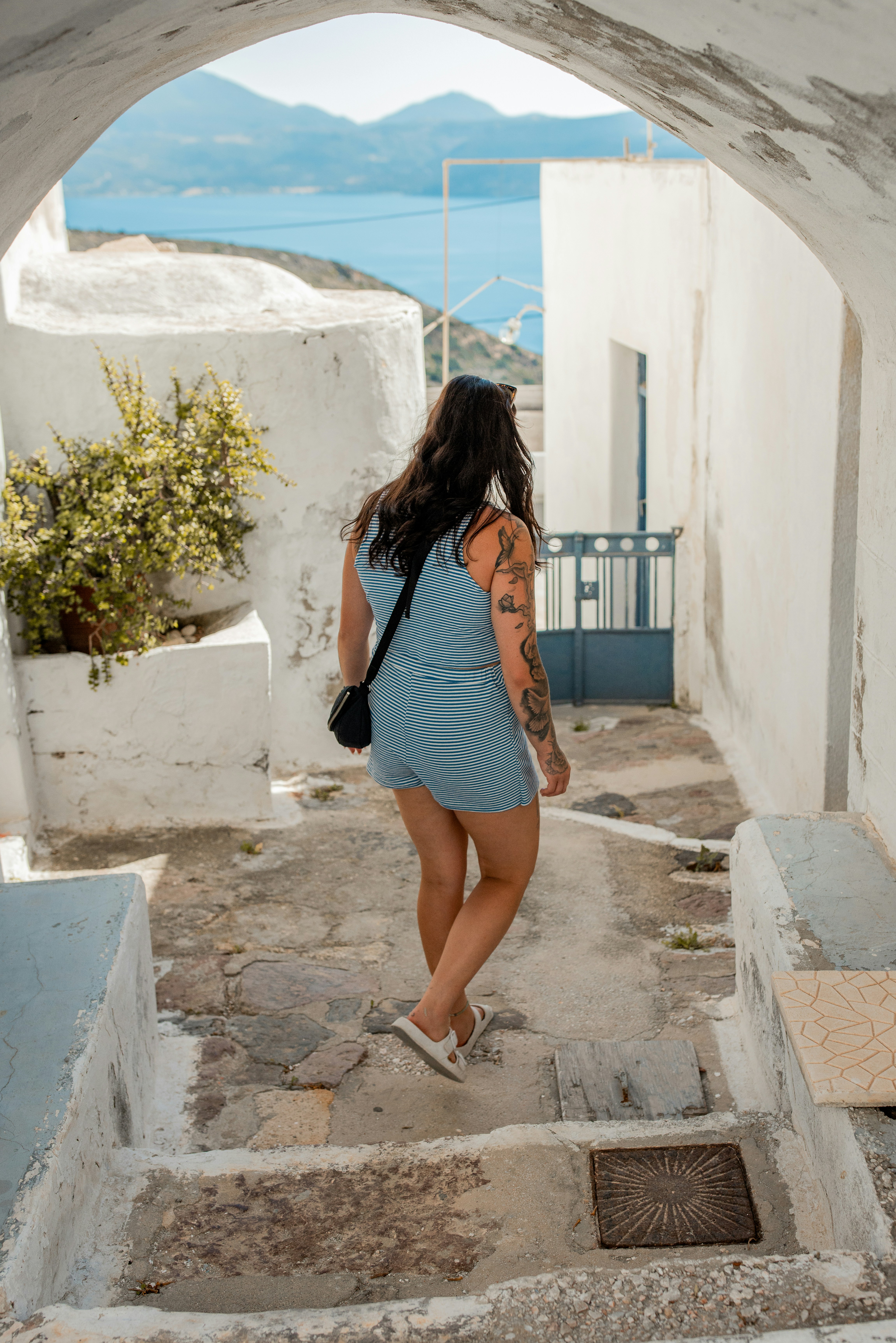 Archway Path to Sea: A Solitary Stroll Down a Whitewashed Passage