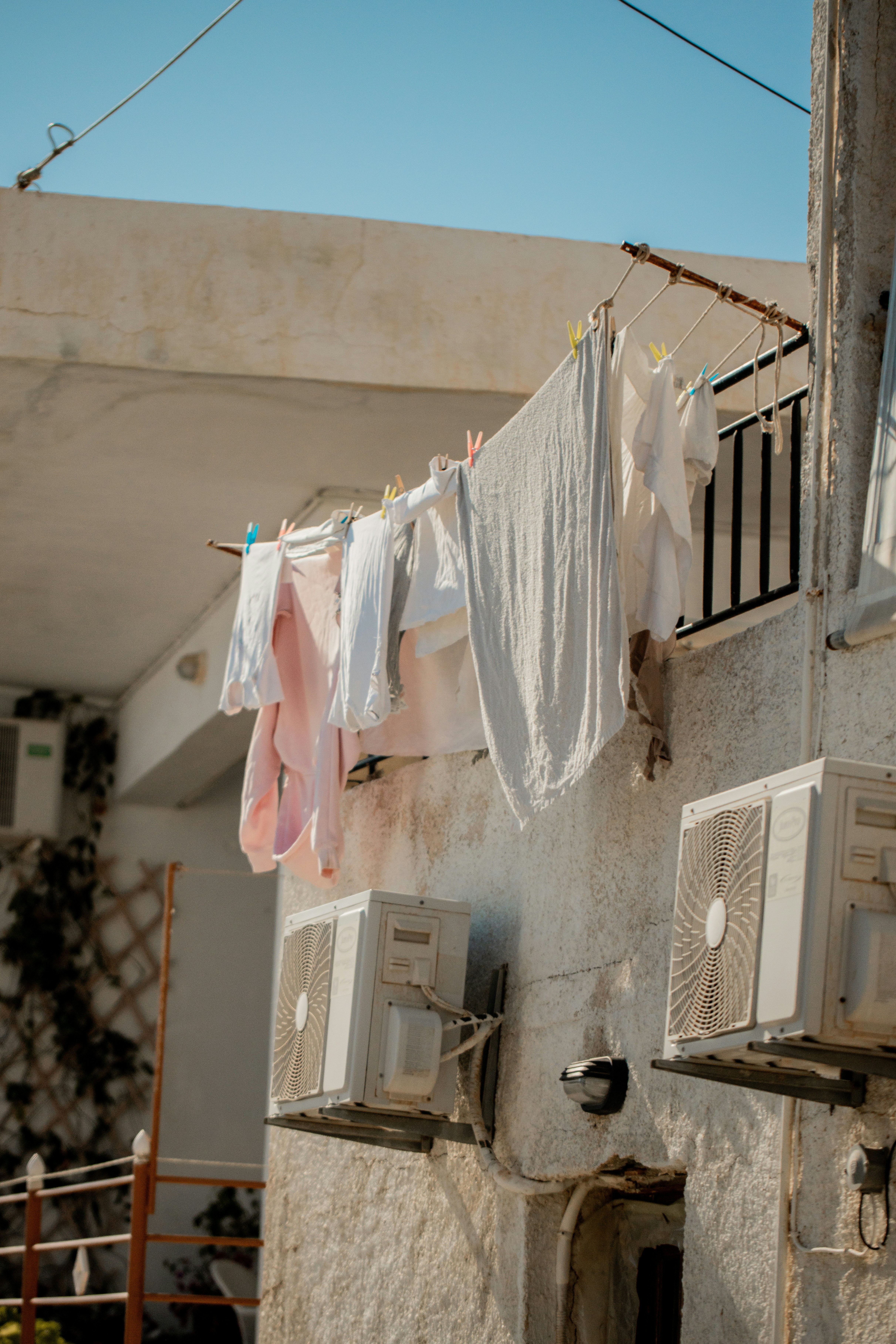 Laundry Lines over a Sunlit Apartment Facade