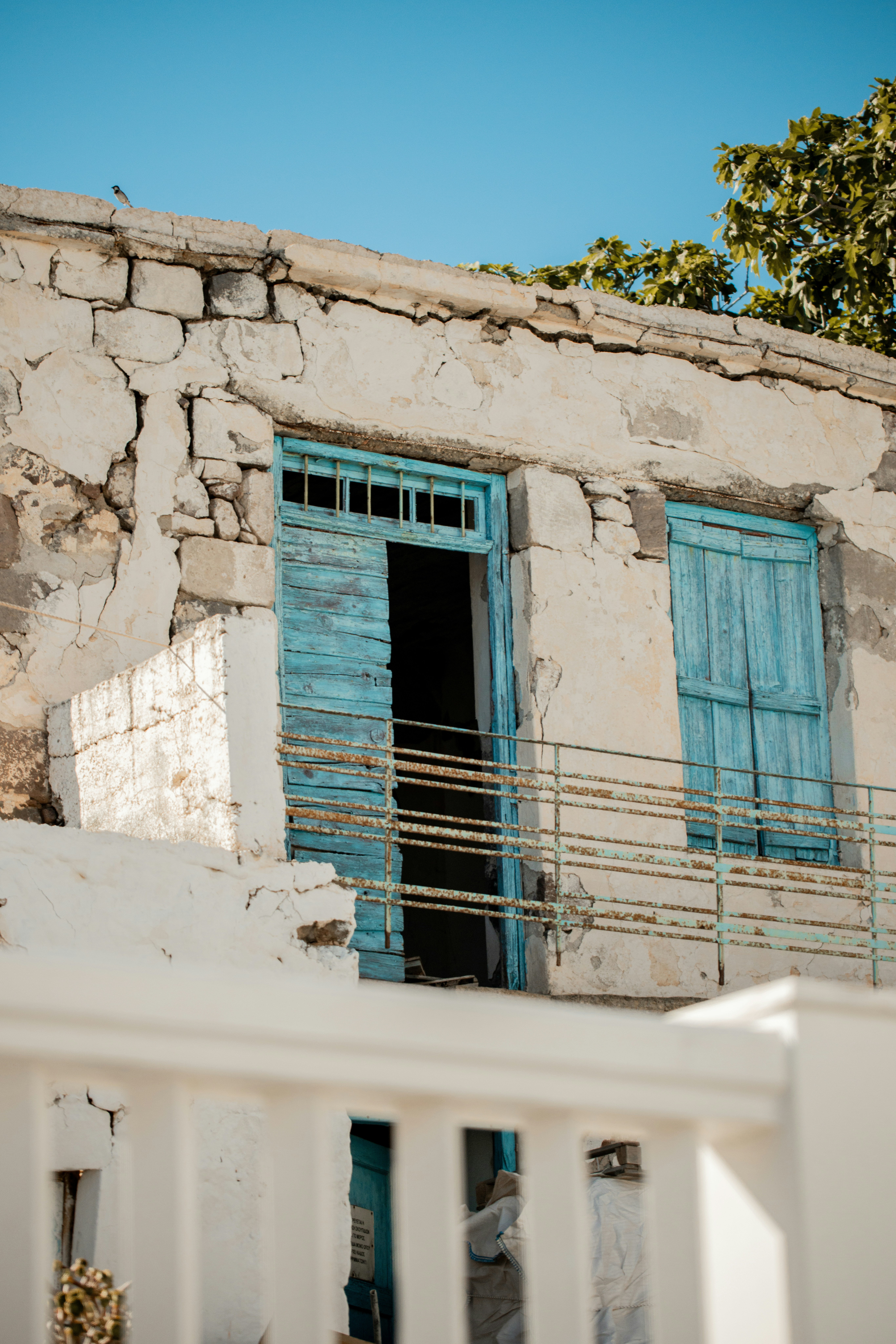 Weathered Blue Doors of a Sunlit Terrace