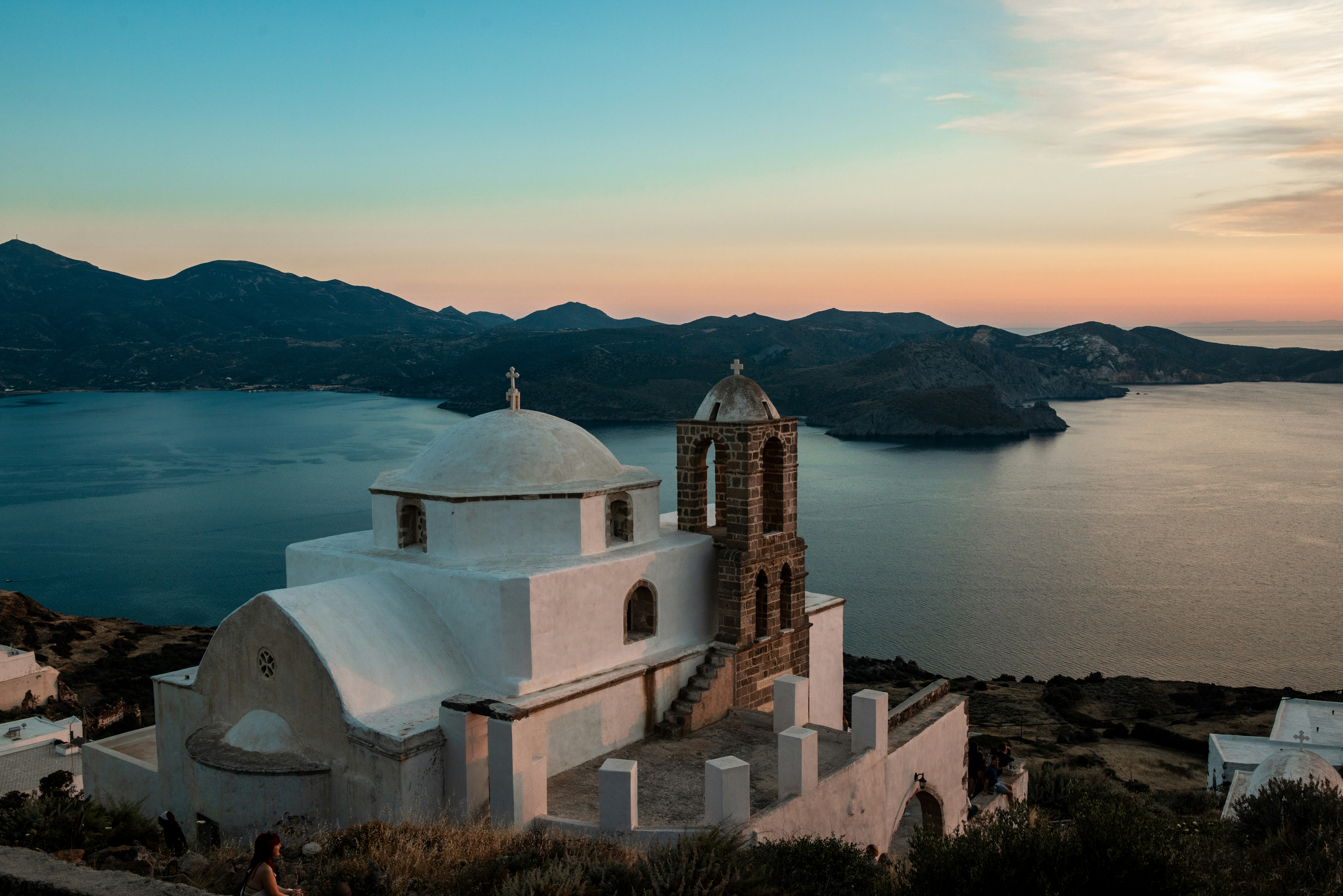Sunset over a Cycladic chapel: whitewashed serenity above the Aegean