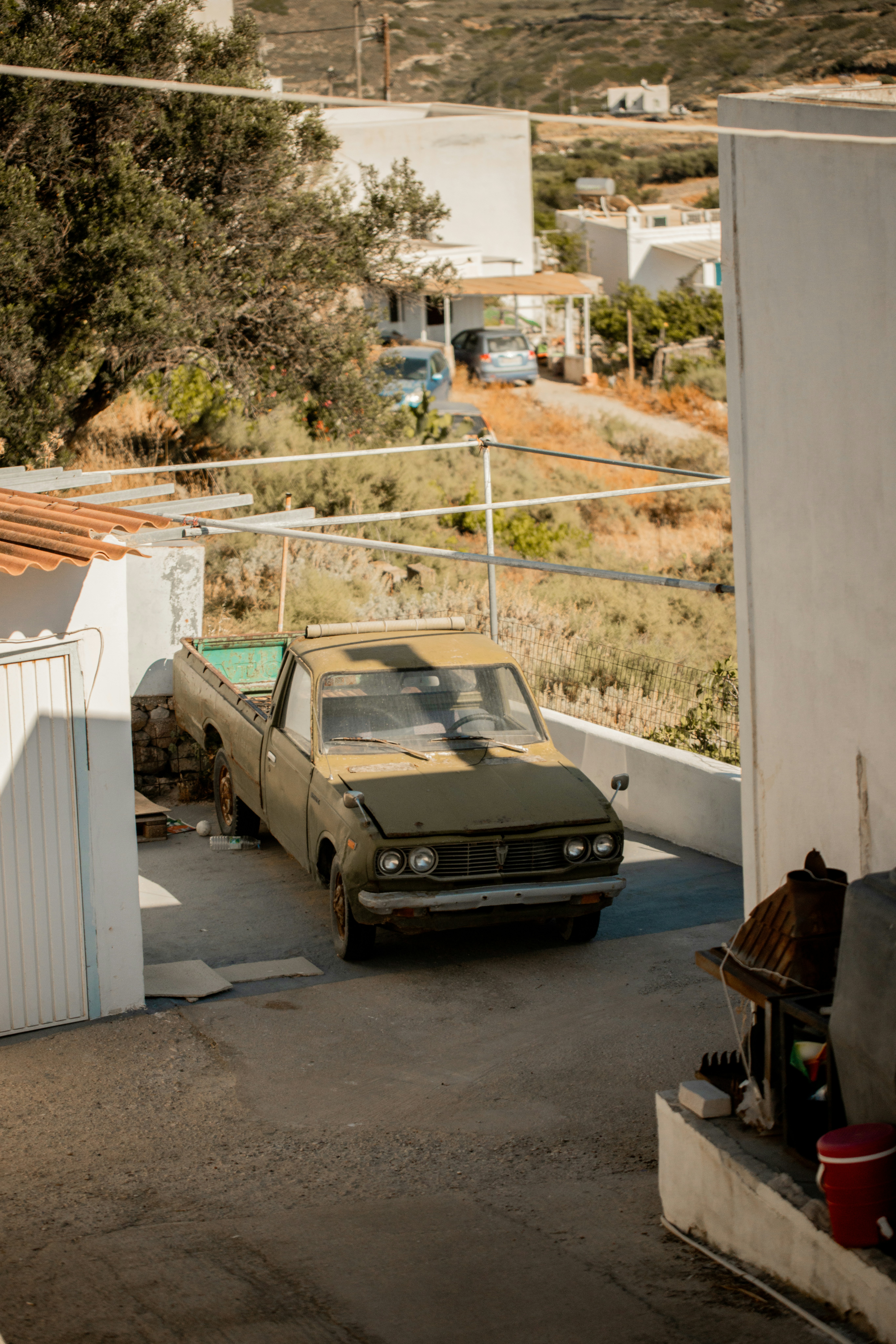 Dusty Pickup in a Sunlit Mediterranean Courtyard