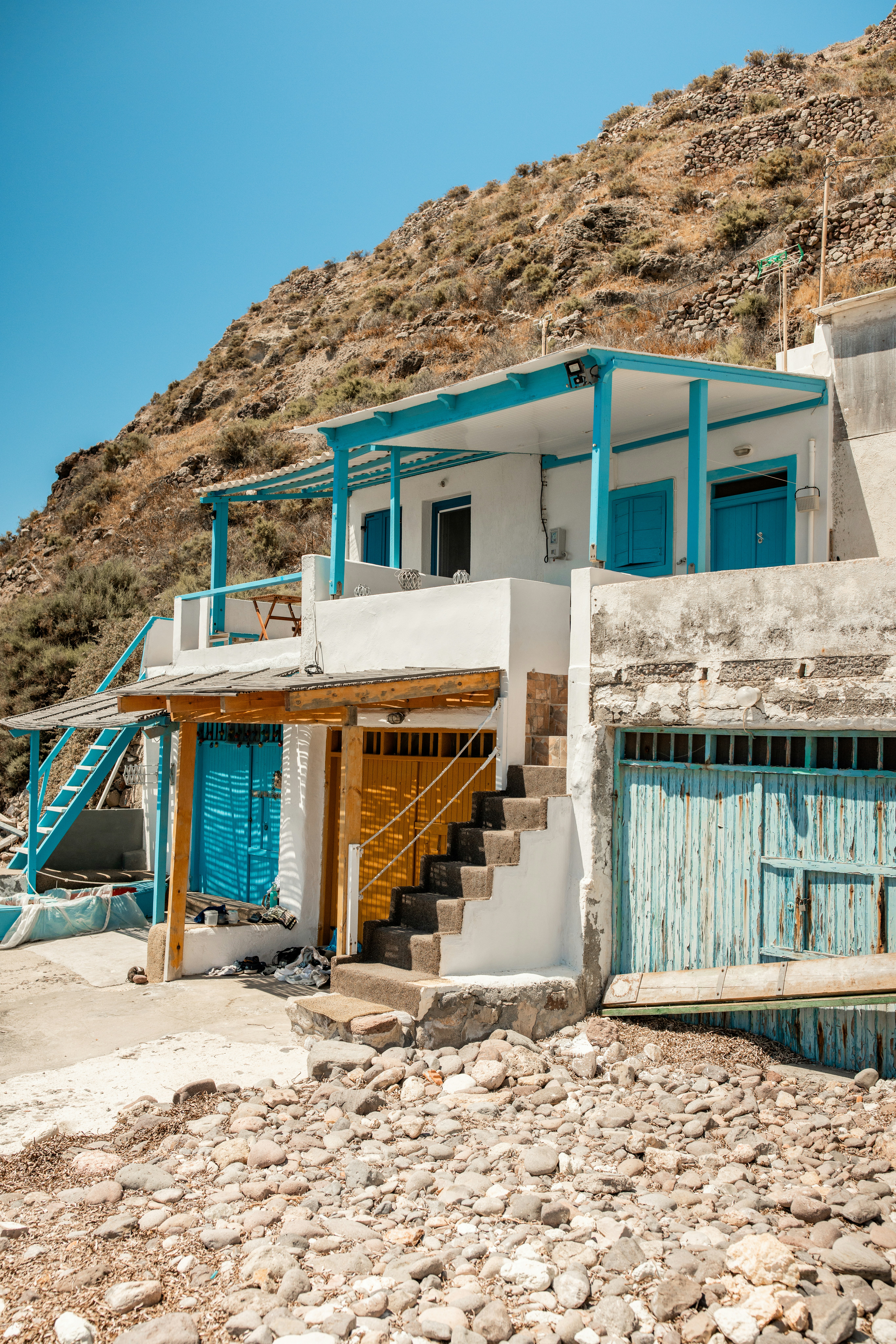 Turquoise Doors and Terraced Life on a Seaside Slope
