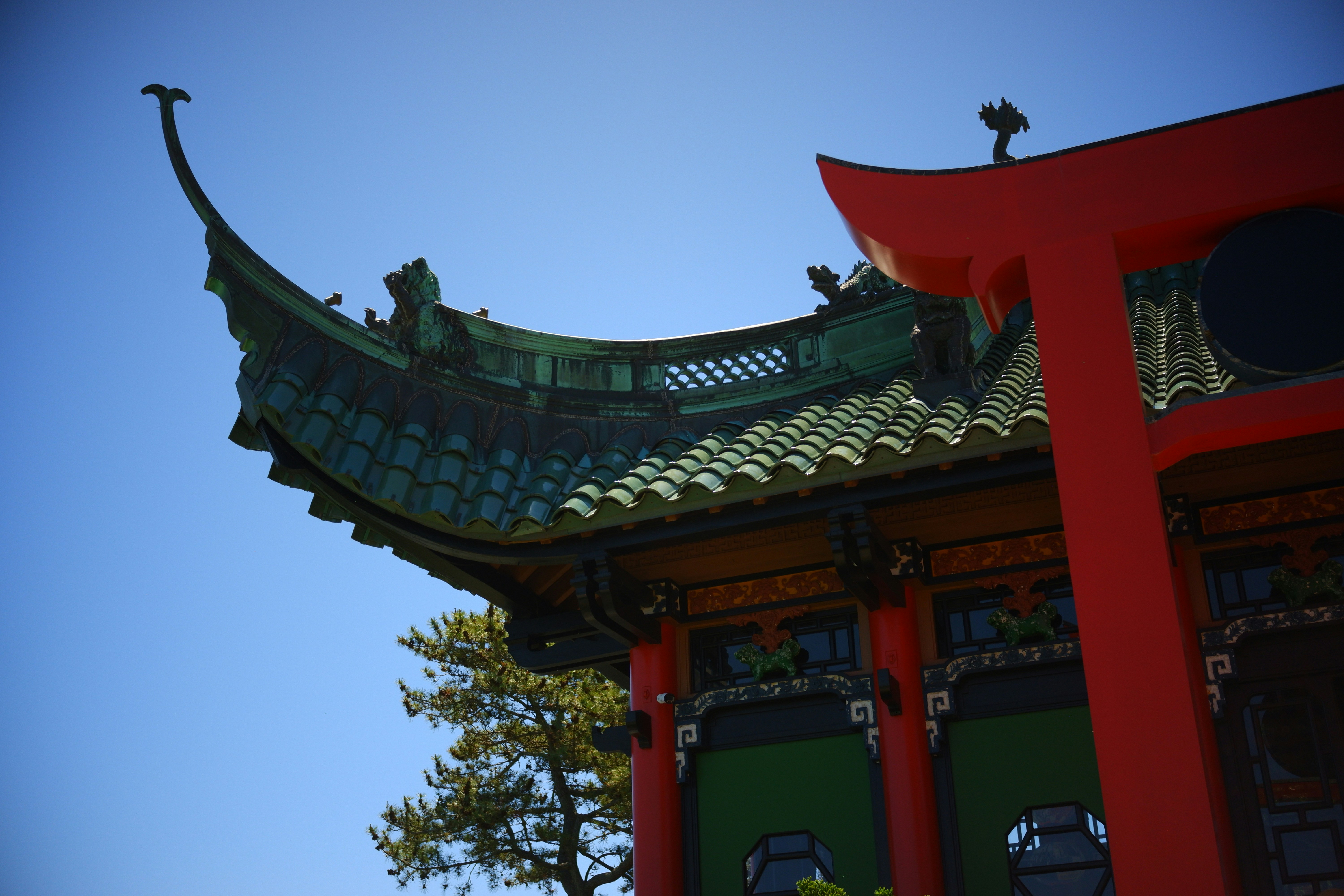 Temple Rooflines and Torii: A Bold Corner Amid Blue Sky