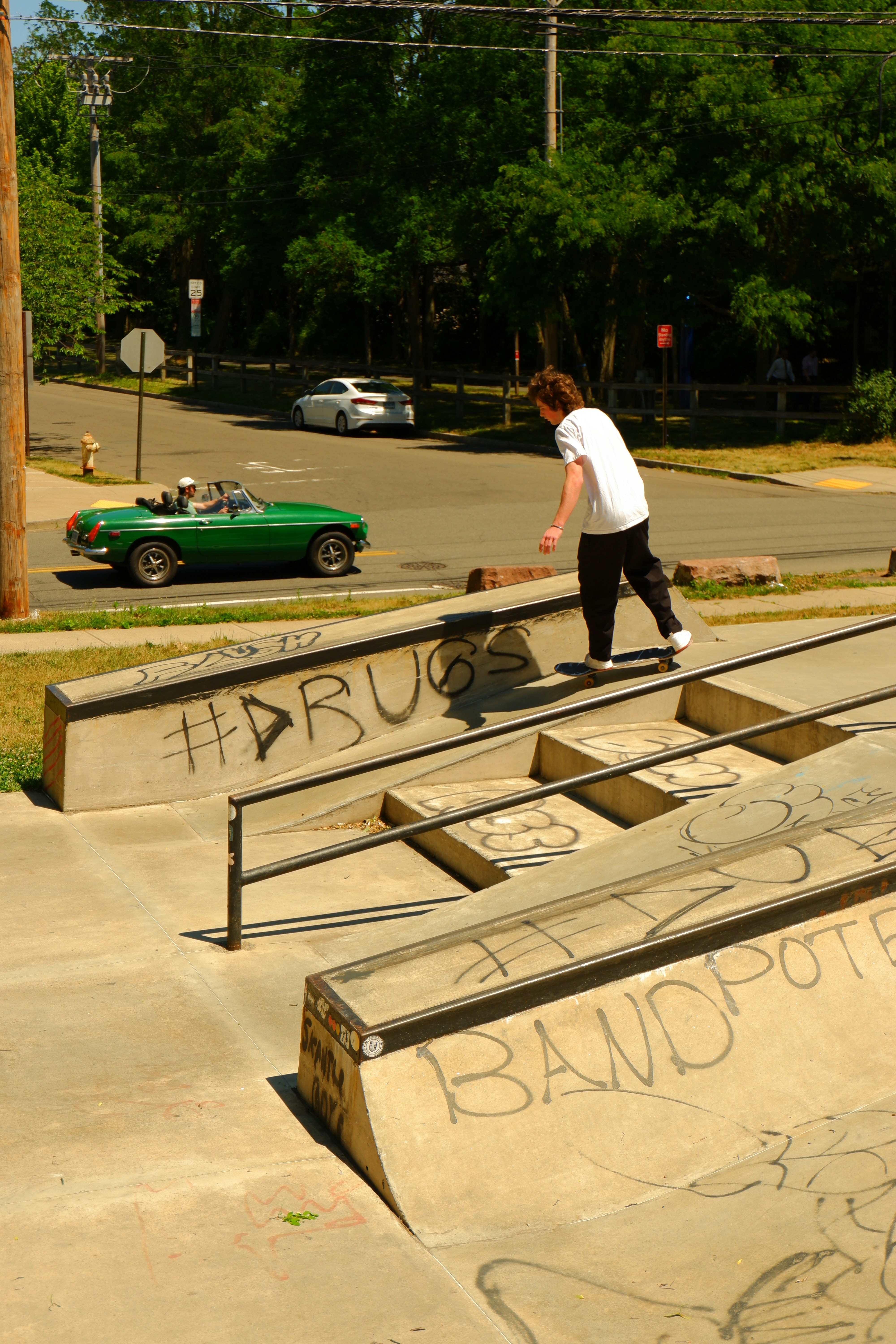 Skater Navigates Graffitied Concrete Ramp Under Summer Light