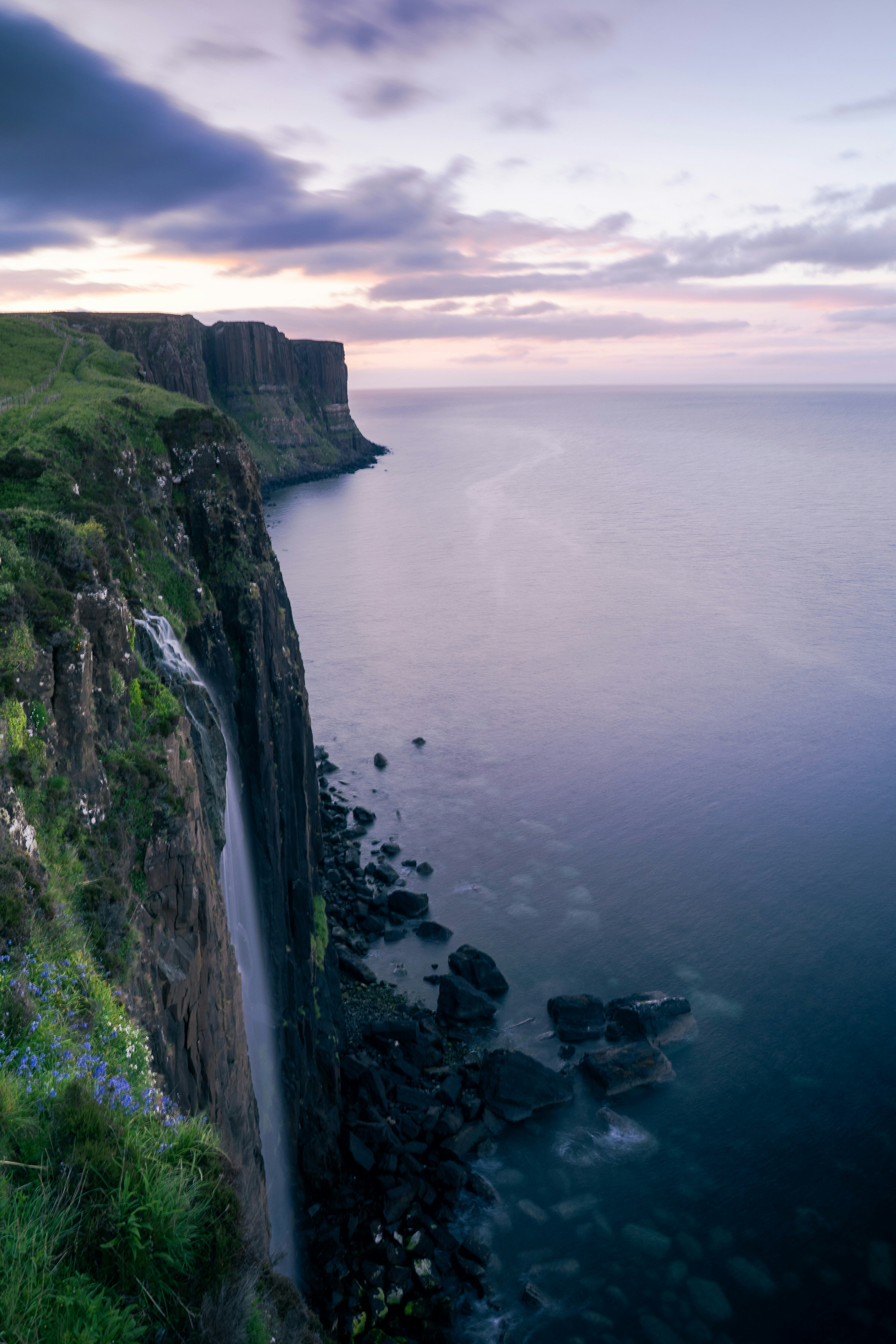 Cliff Edge at Sunset: A Quiet Sea Aglow