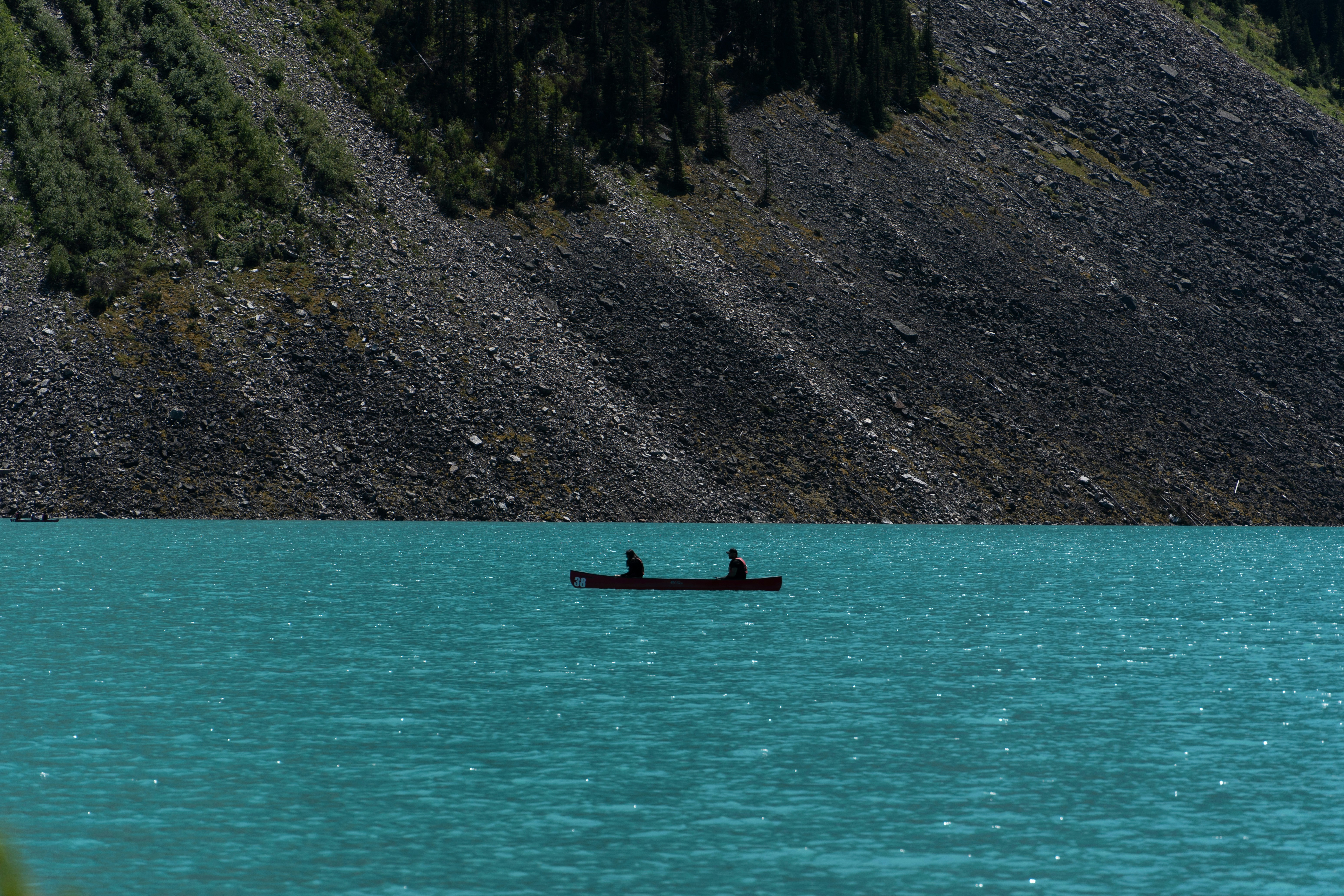 Canoe Silhouette Amid Turquoise Silence