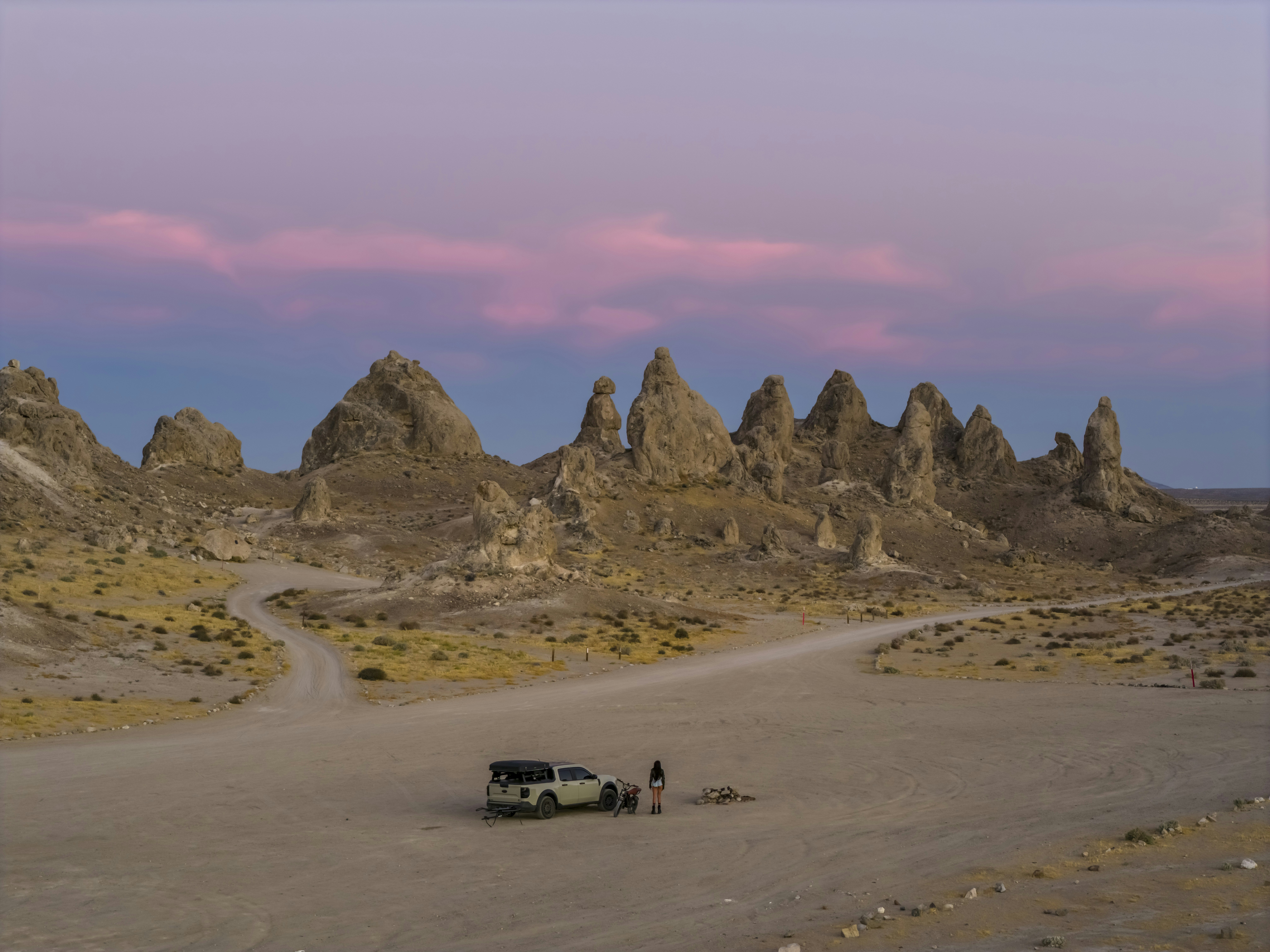 Desert Vista at Dusk: A Jeep and Hikers Meet the Rock Formations
