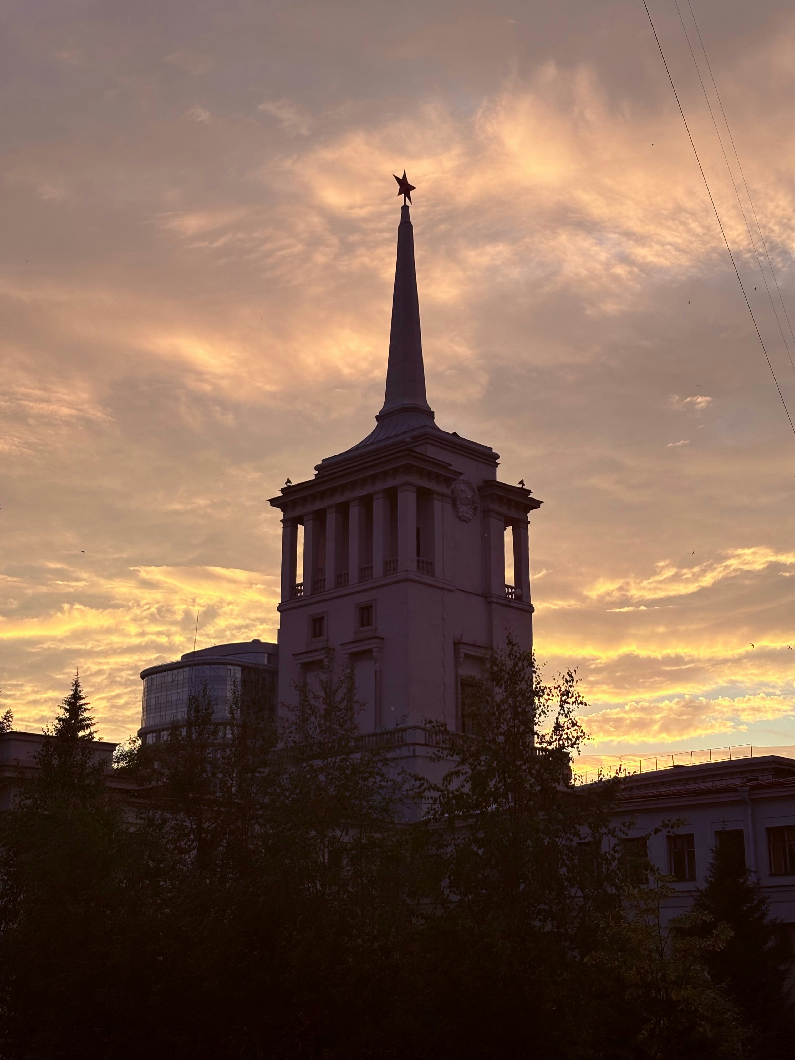 Sunset Spire: A Clocktower Silhouette Against Warm Skies