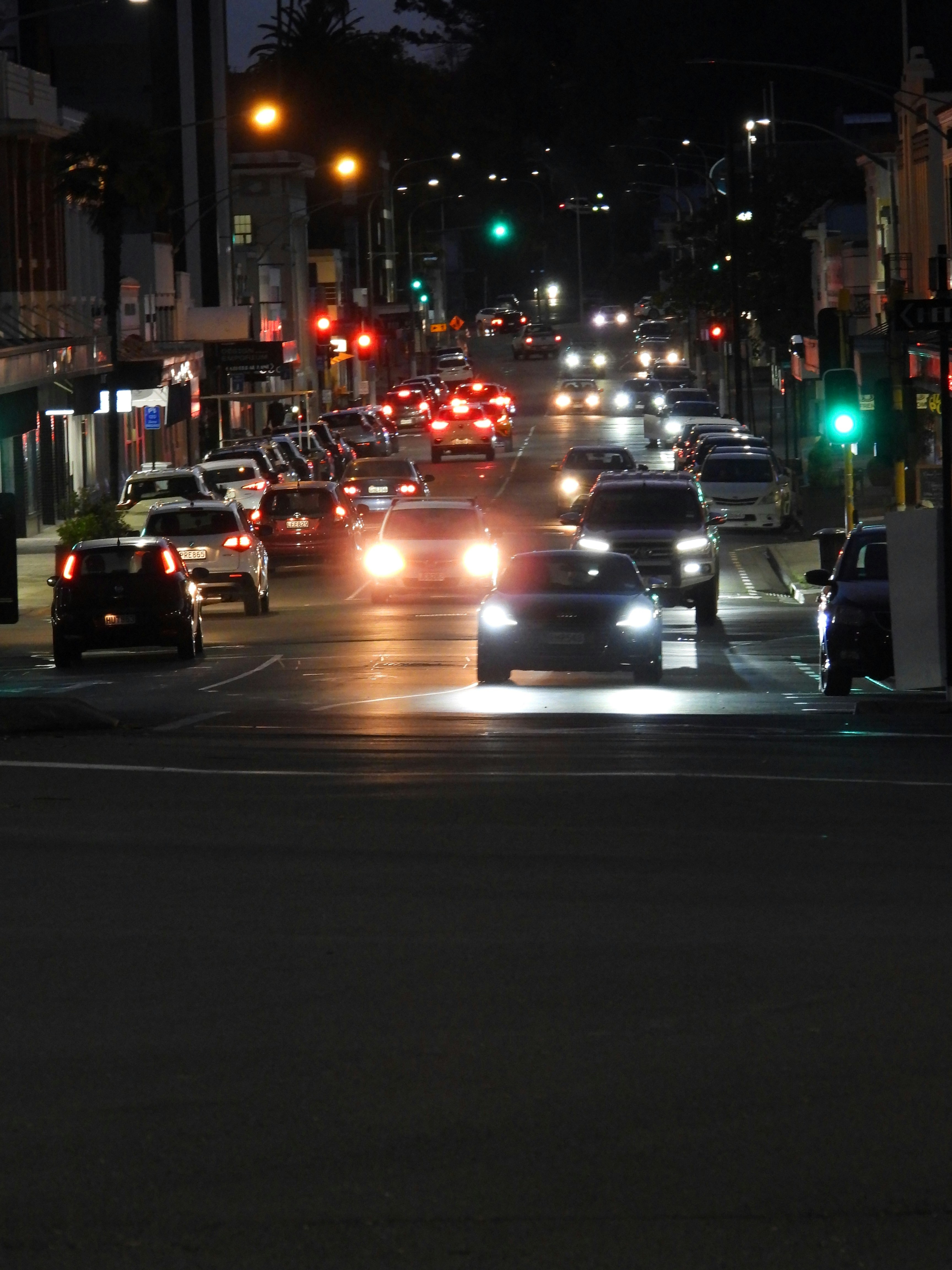 Streetline at Dusk: Headlights Converge in a Quiet City Block