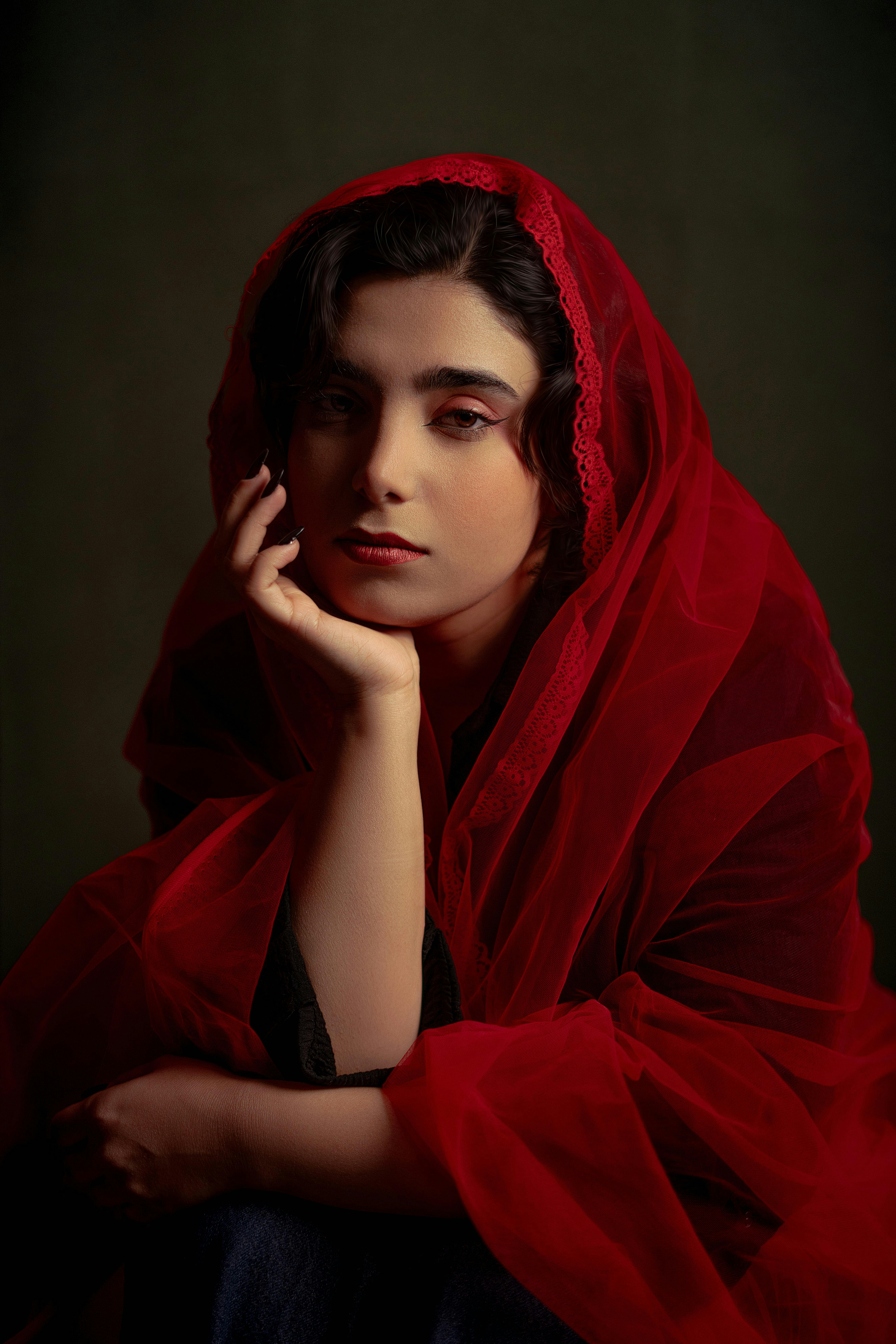 Veiled Intensity: A Red Veil Framing Quiet Thought