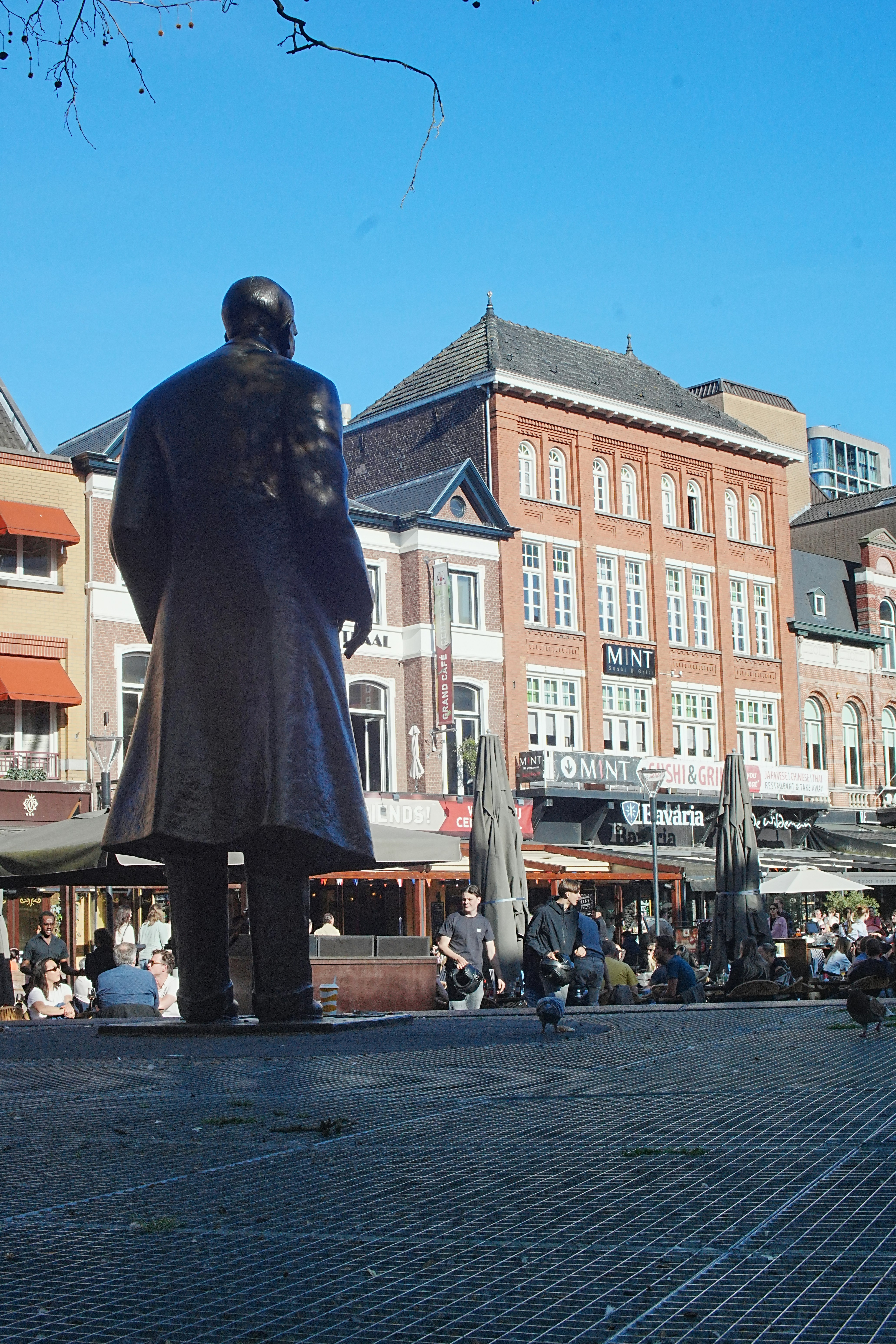 Silhouette of a Civic Watcher: A Statue Overlooking a Sunlit Square
